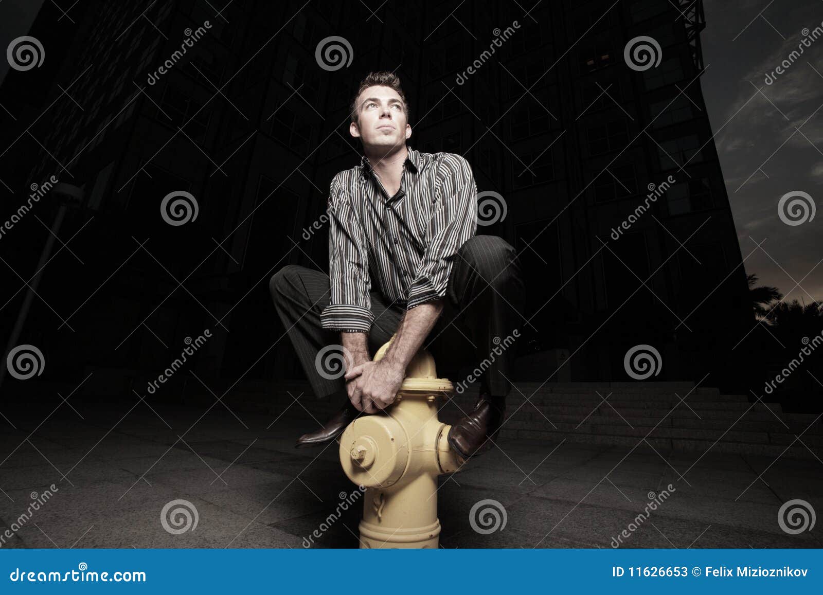 Man Posed on a Fire Hydrant Stock Image - Image of posed, hydrant: 11626653