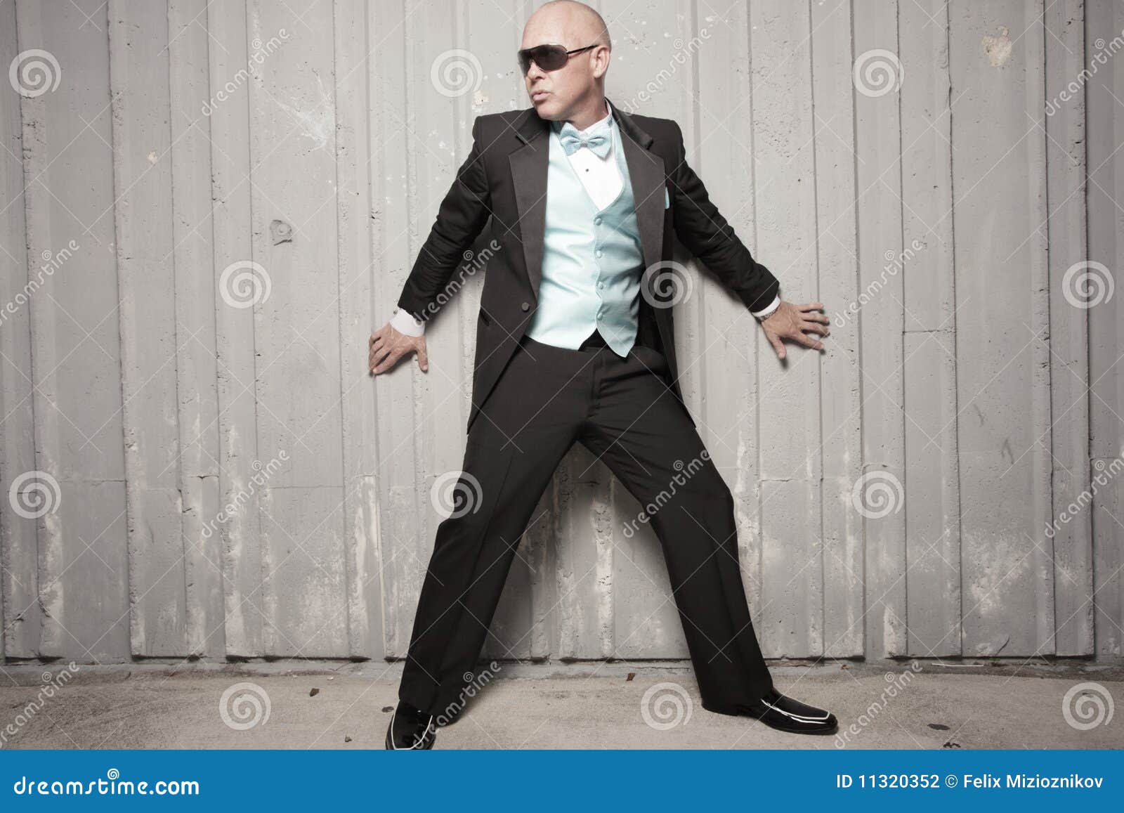 Man Posing Against a Concrete Wall Stock Photo - Image of tuxedo ...