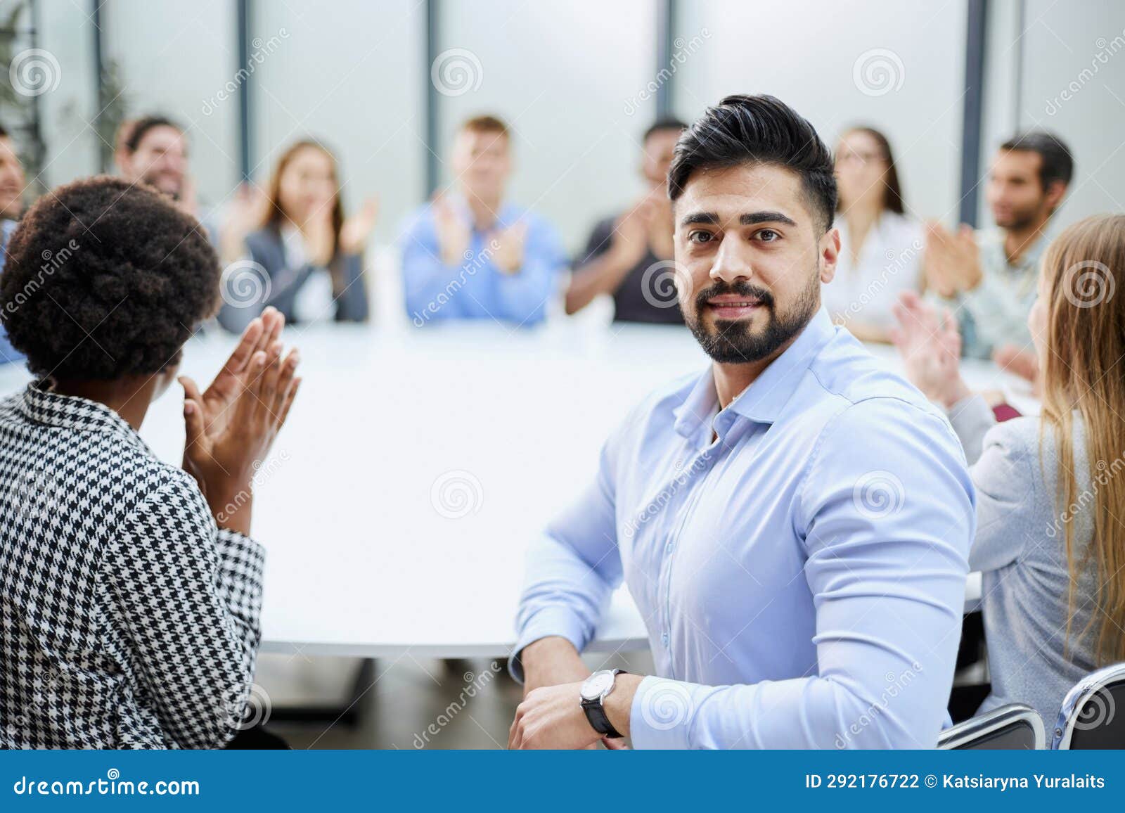 A Man Posing for the Camera while Sitting at a Round Table Stock Photo ...