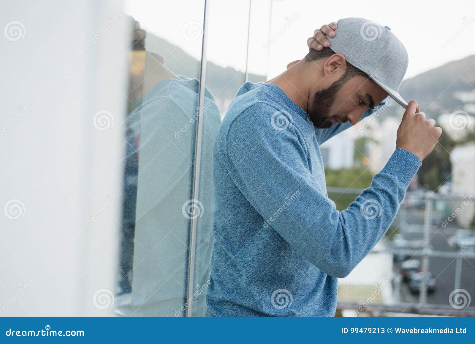 Man Posing in Cap Against Glass Stock Image - Image of posing, handsome ...