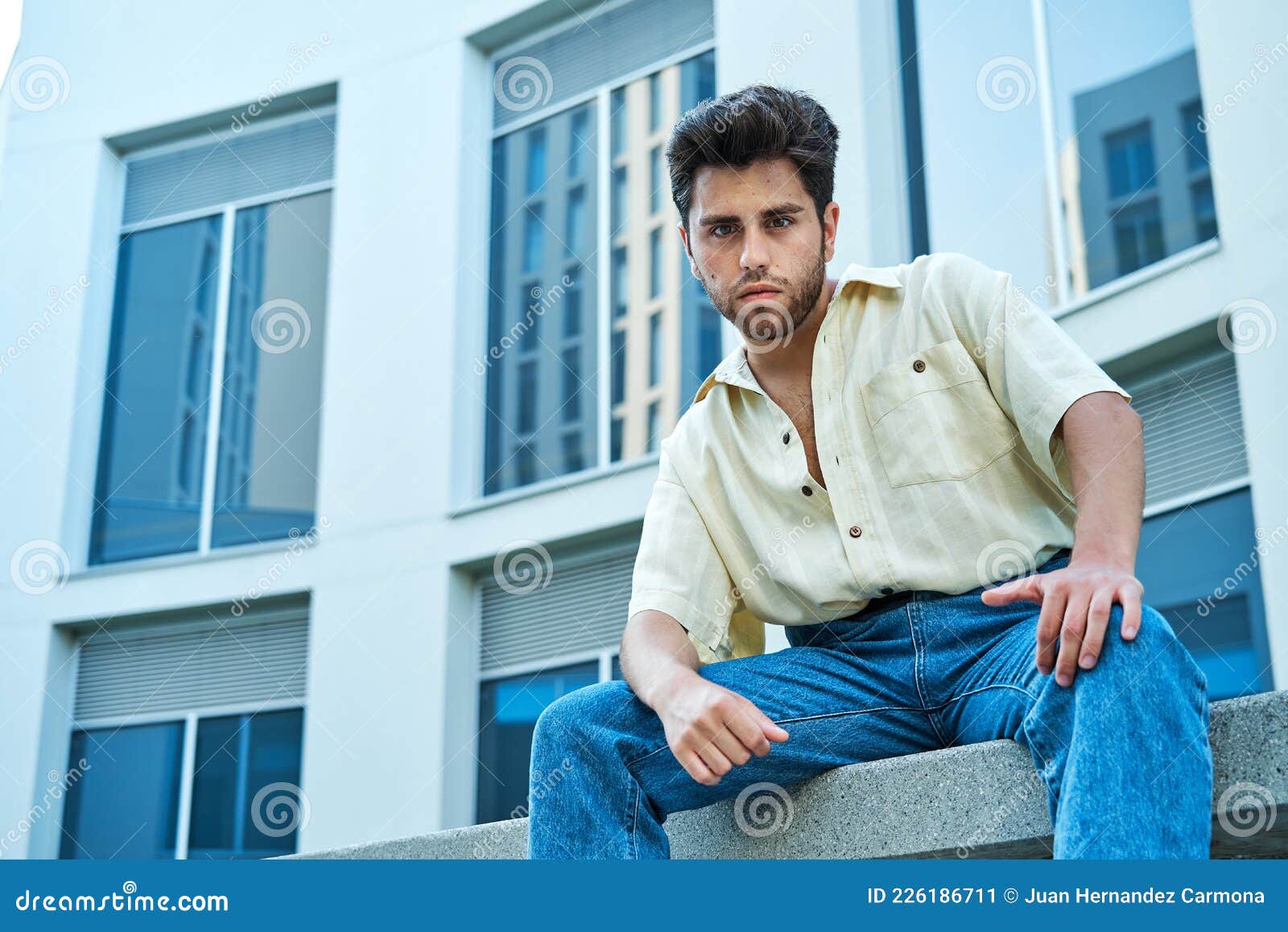 Man Posing in Front of a Building with Large Windows Stock Image ...