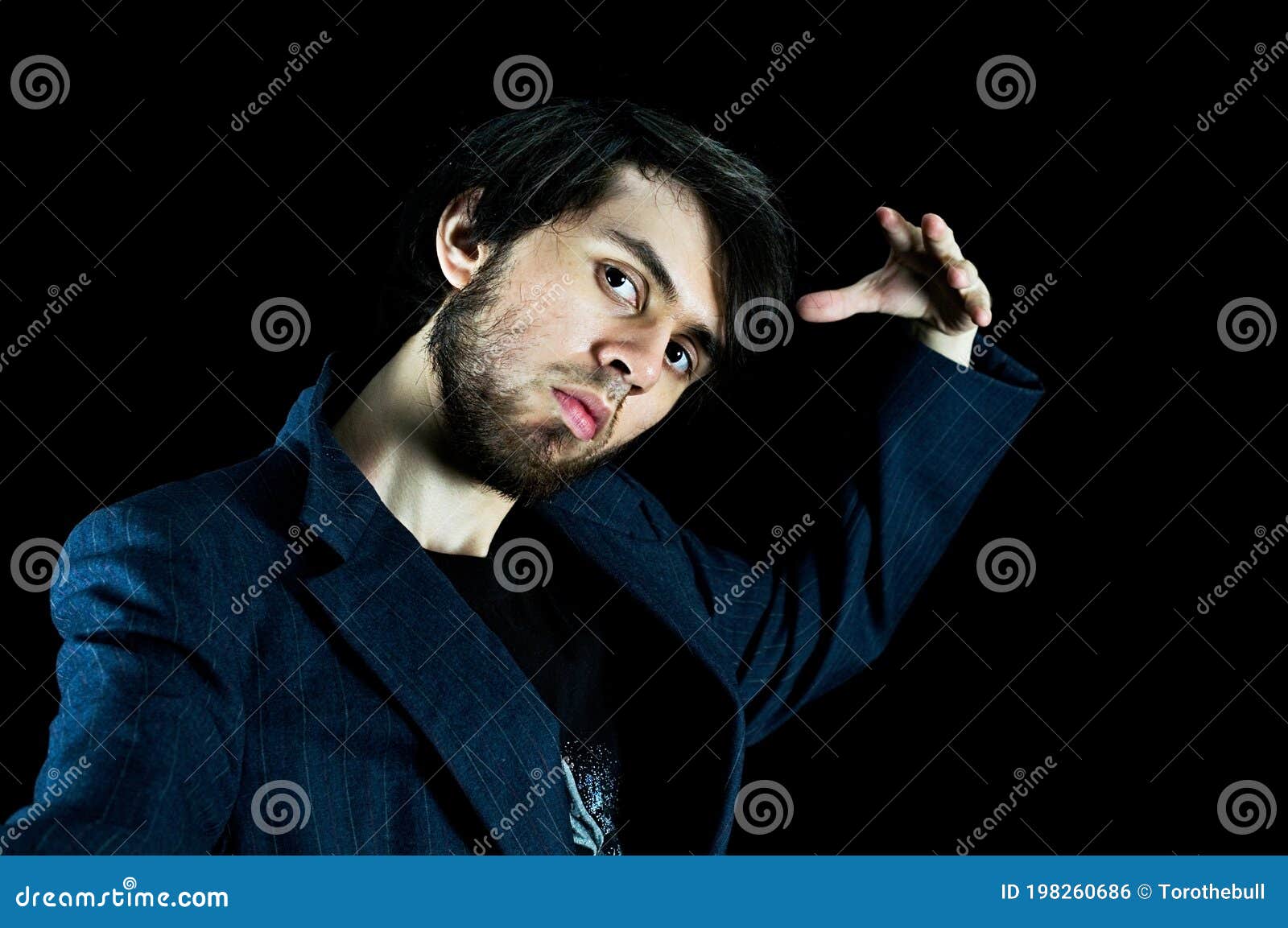 Man Posing with His Left Hand Up, with His Head Tilted Stock Photo ...