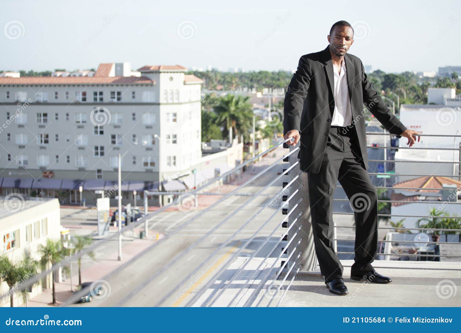Man posing by the ledge stock photo. Image of focus, handsome - 21105684