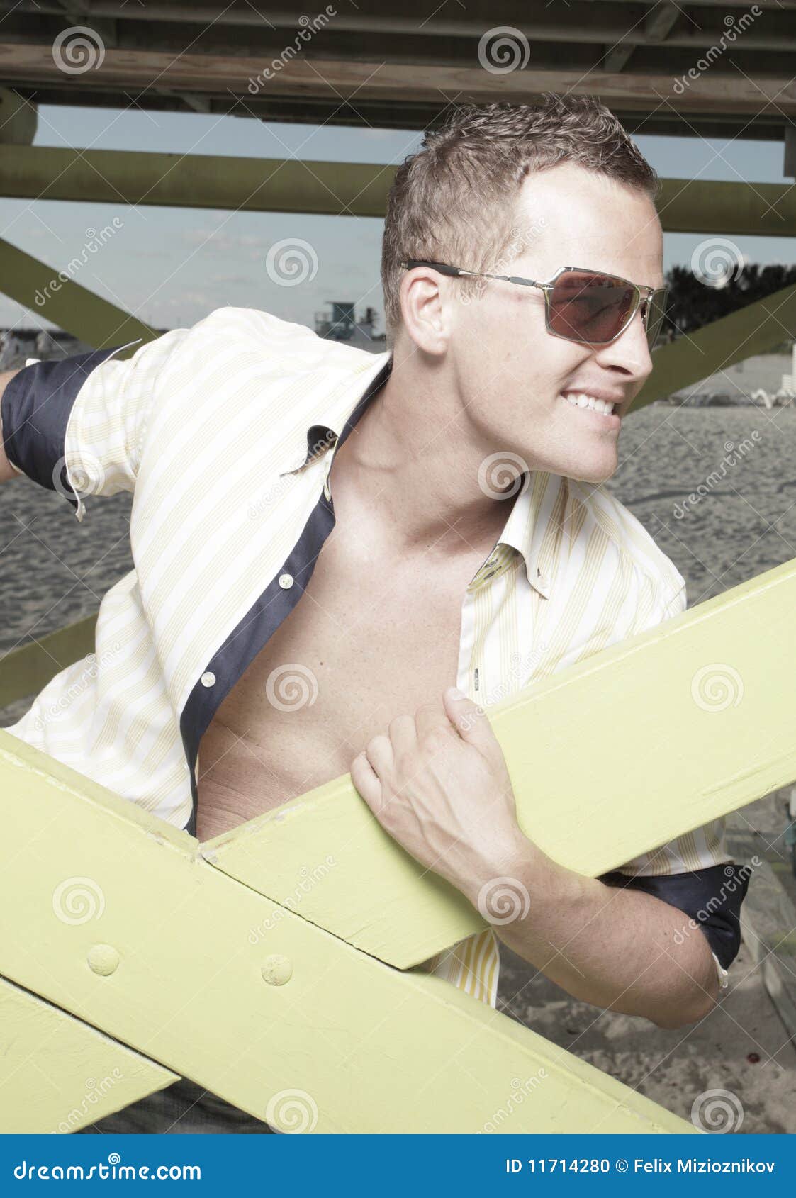 Man Posing by a Lifeguard Stand Stock Photo - Image of young, handsome ...