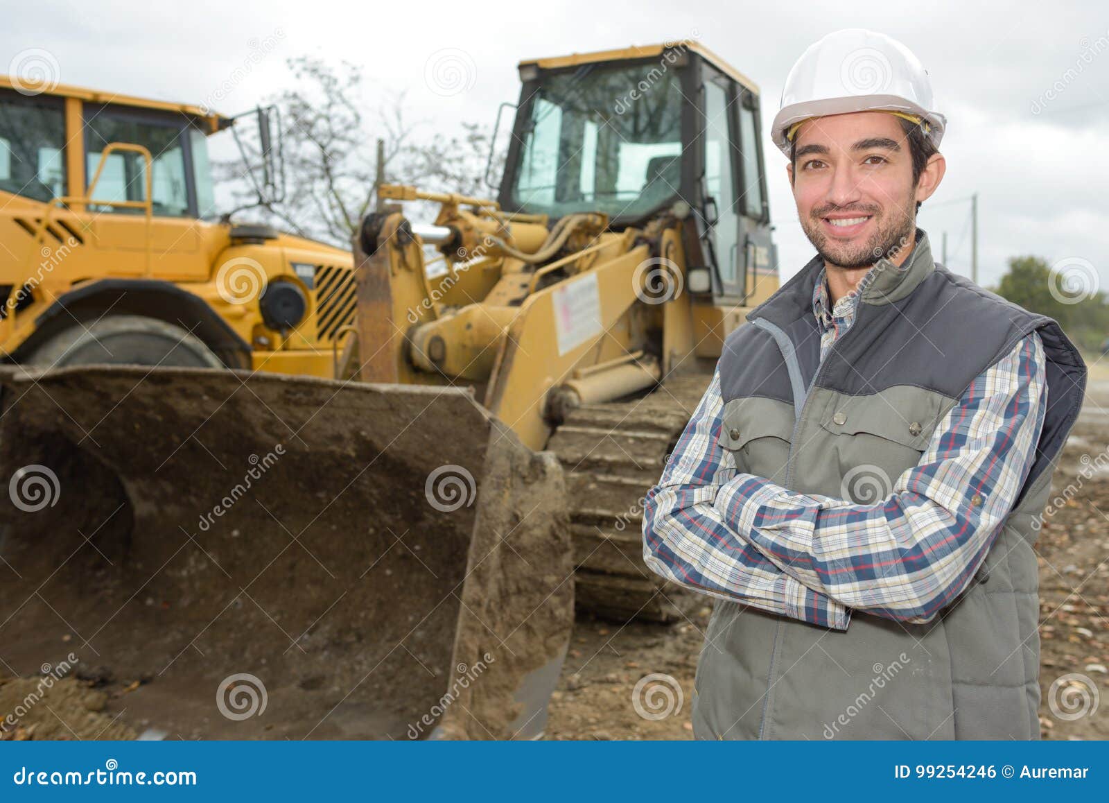 Man posing next to backhoe stock photo. Image of equipment - 99254246