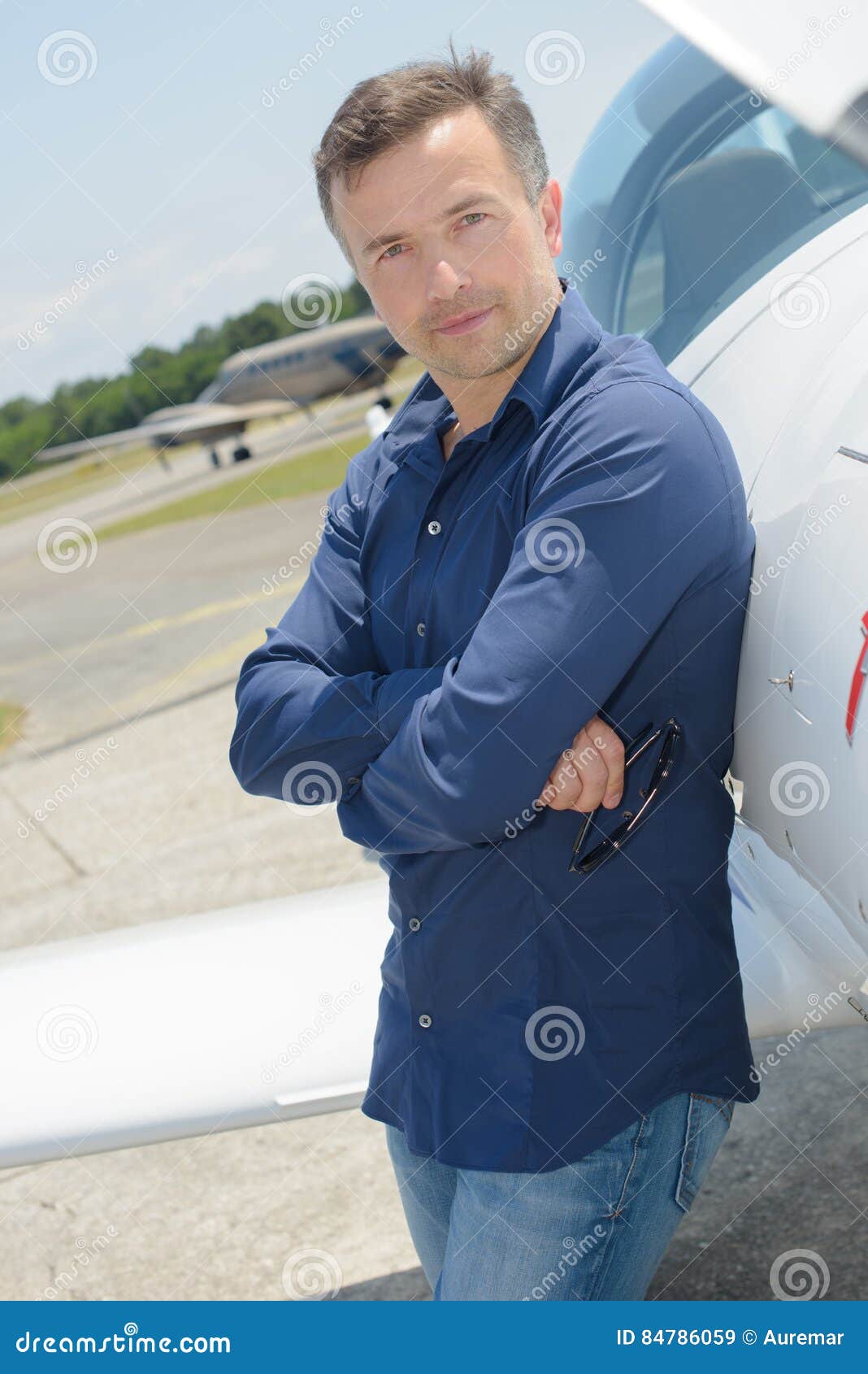 Man posing with plane stock image. Image of stable, elegance - 84786059