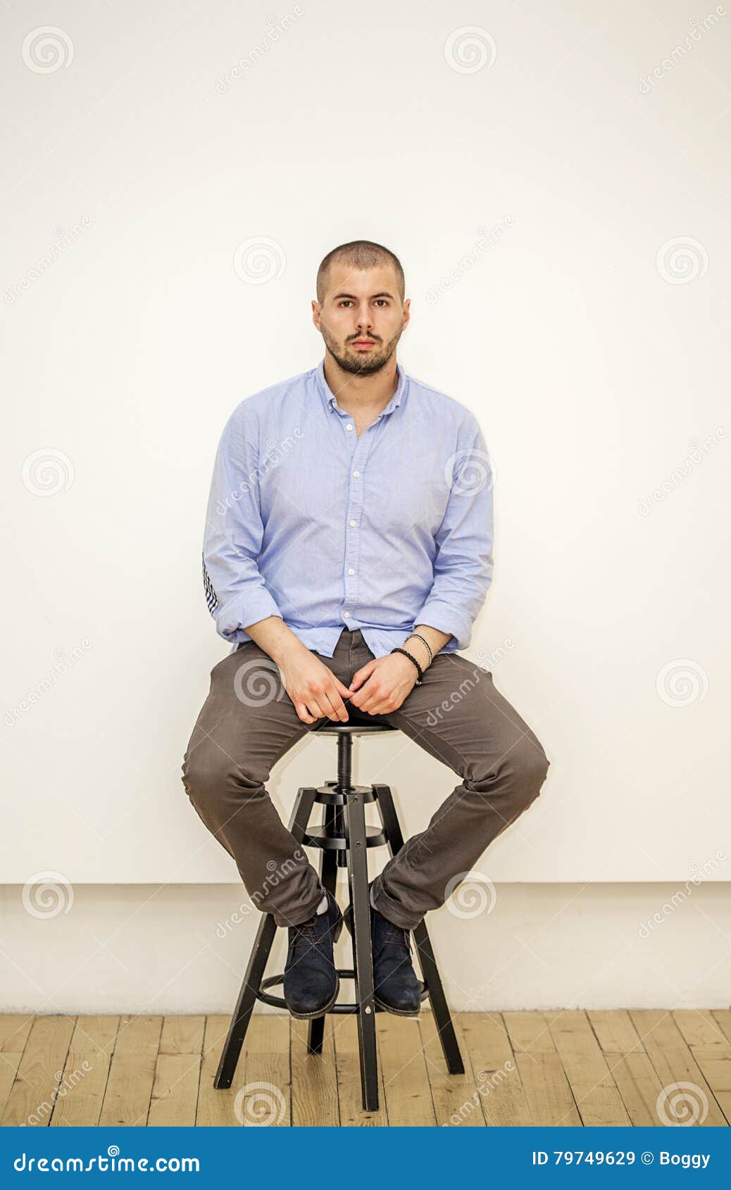 Man posing on the stool stock image. Image of casual - 79749629