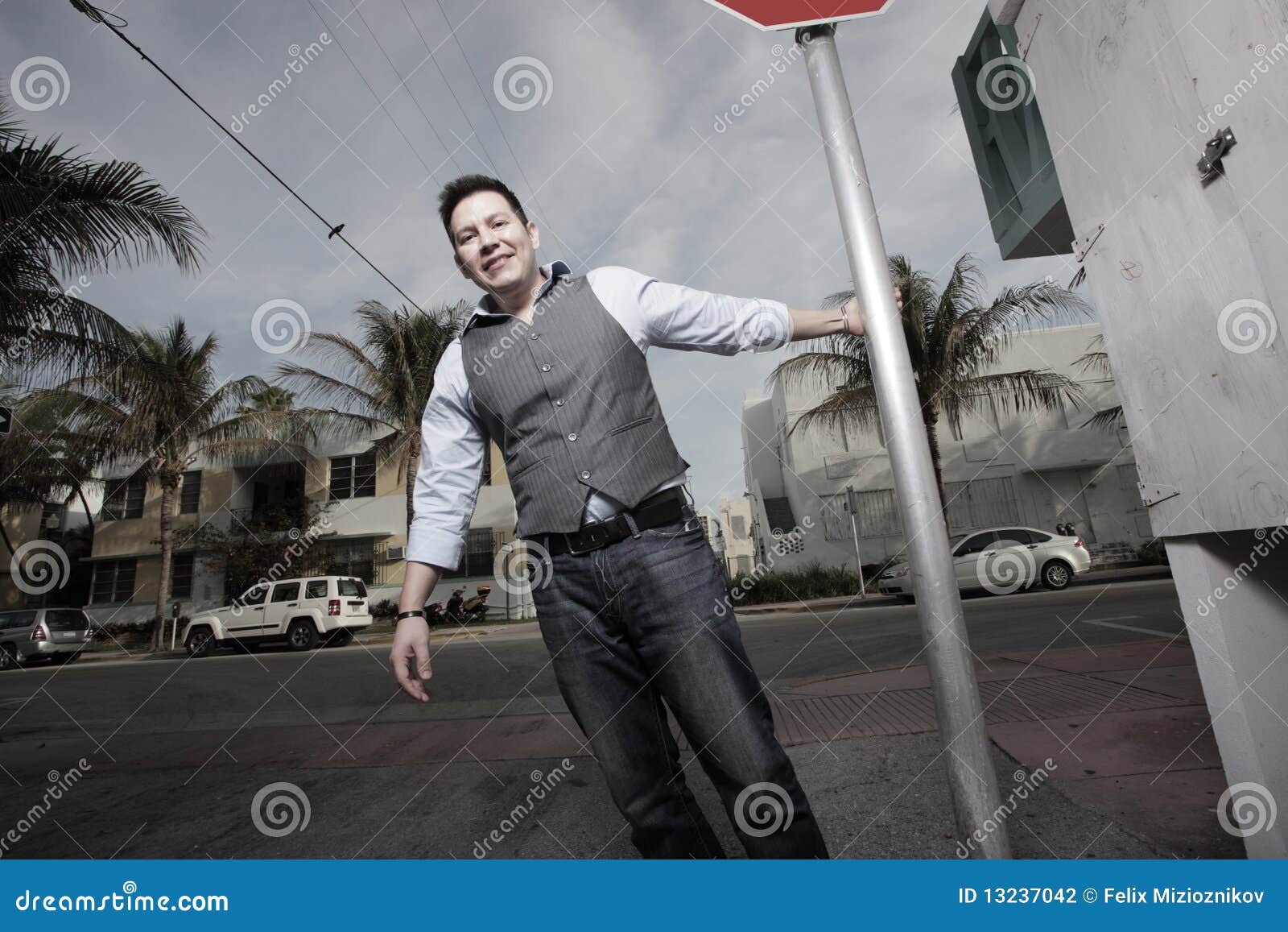 Man posing by a stop sign stock photo. Image of street - 13237042