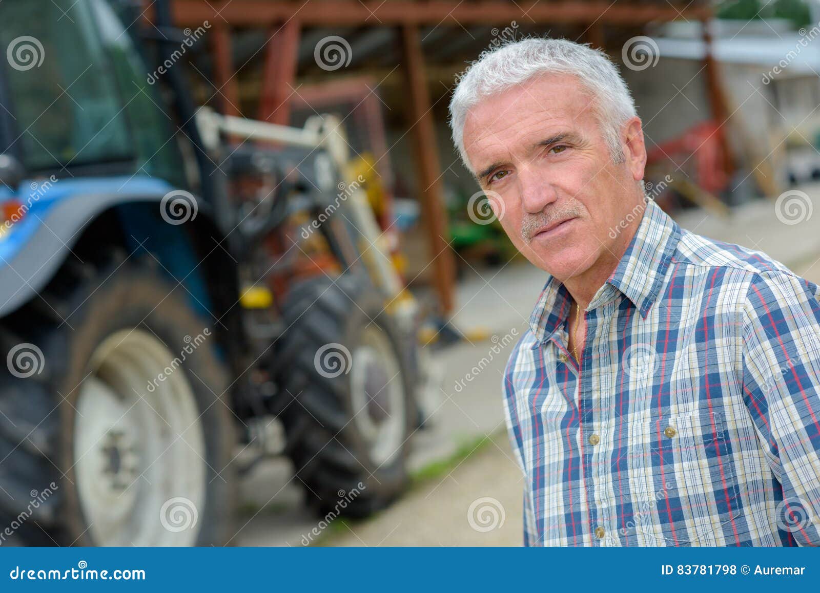 Man posing with tractor stock photo. Image of profession - 83781798