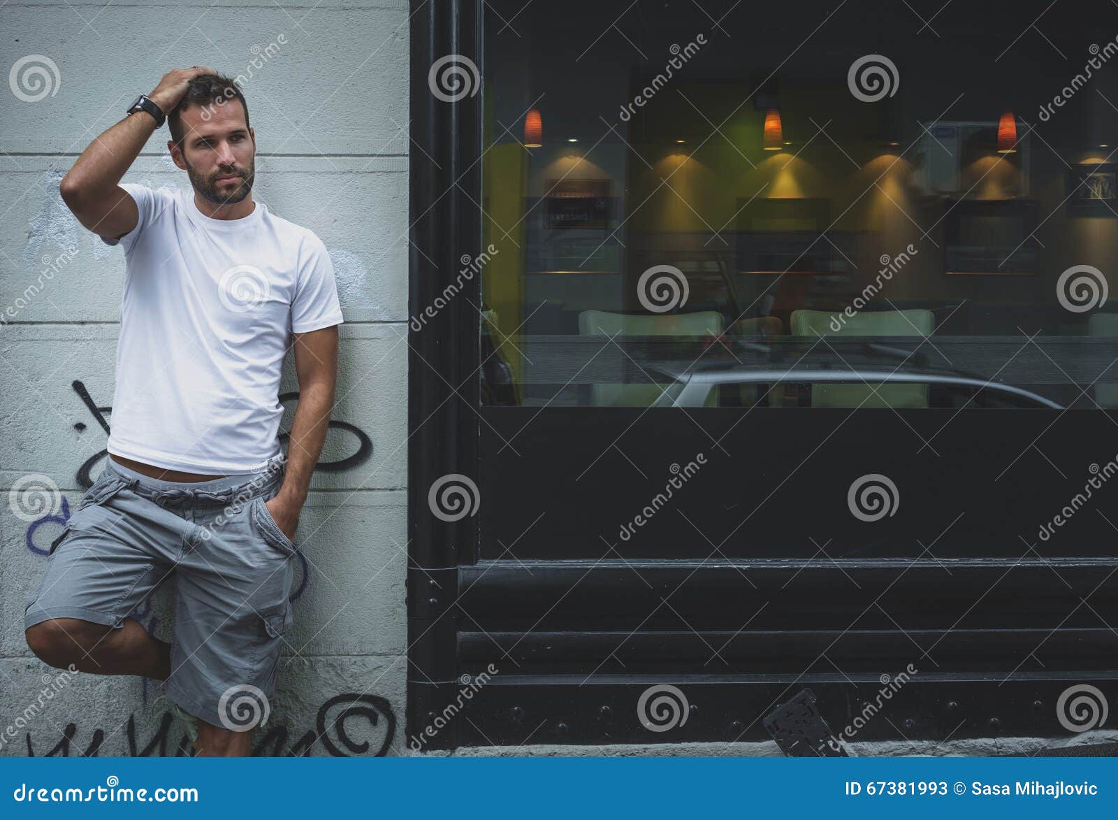 Man posing on a wall stock image. Image of fashion, pants - 67381993