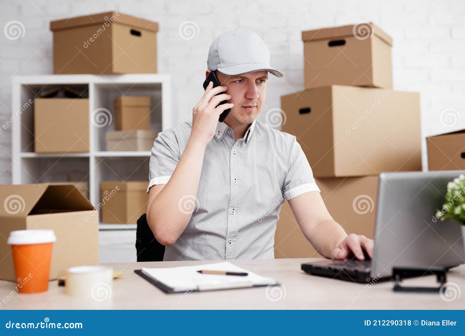 Man in Post Office Talking by Phone and Checking the Order Stock Photo ...