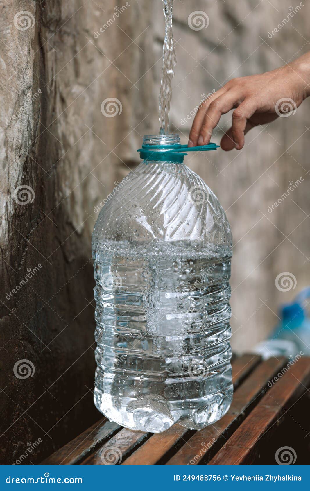 Man Pour Fresh Spring Water into Plastic Bottle from a Natural Source ...