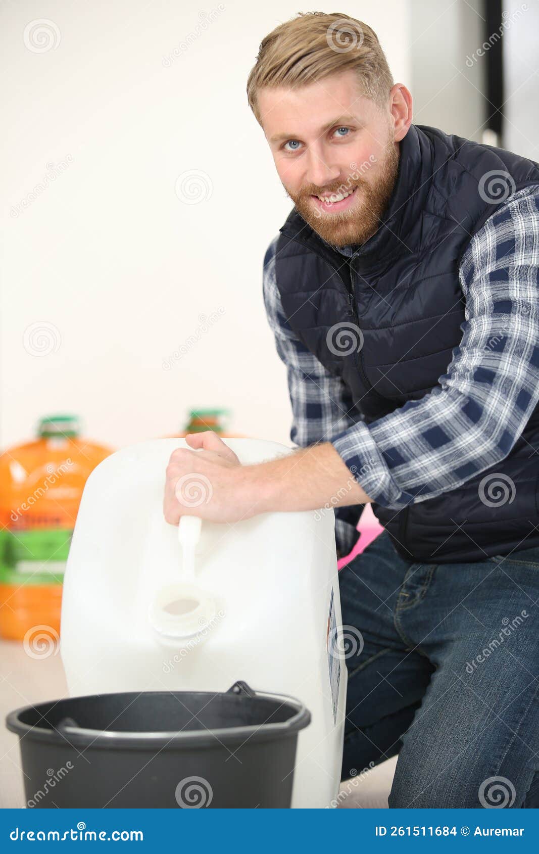 Man Pouring Chemical from Container into Bucket Stock Photo - Image of ...