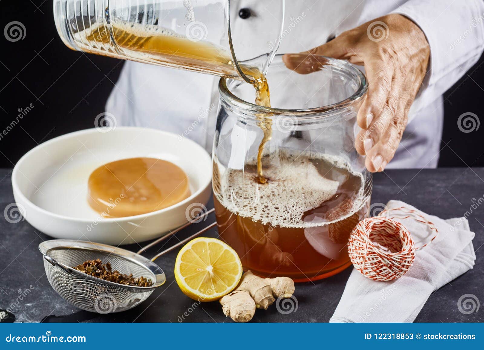 Man Pouring Kombucha Tea into Jar Stock Image - Image of beverage ...