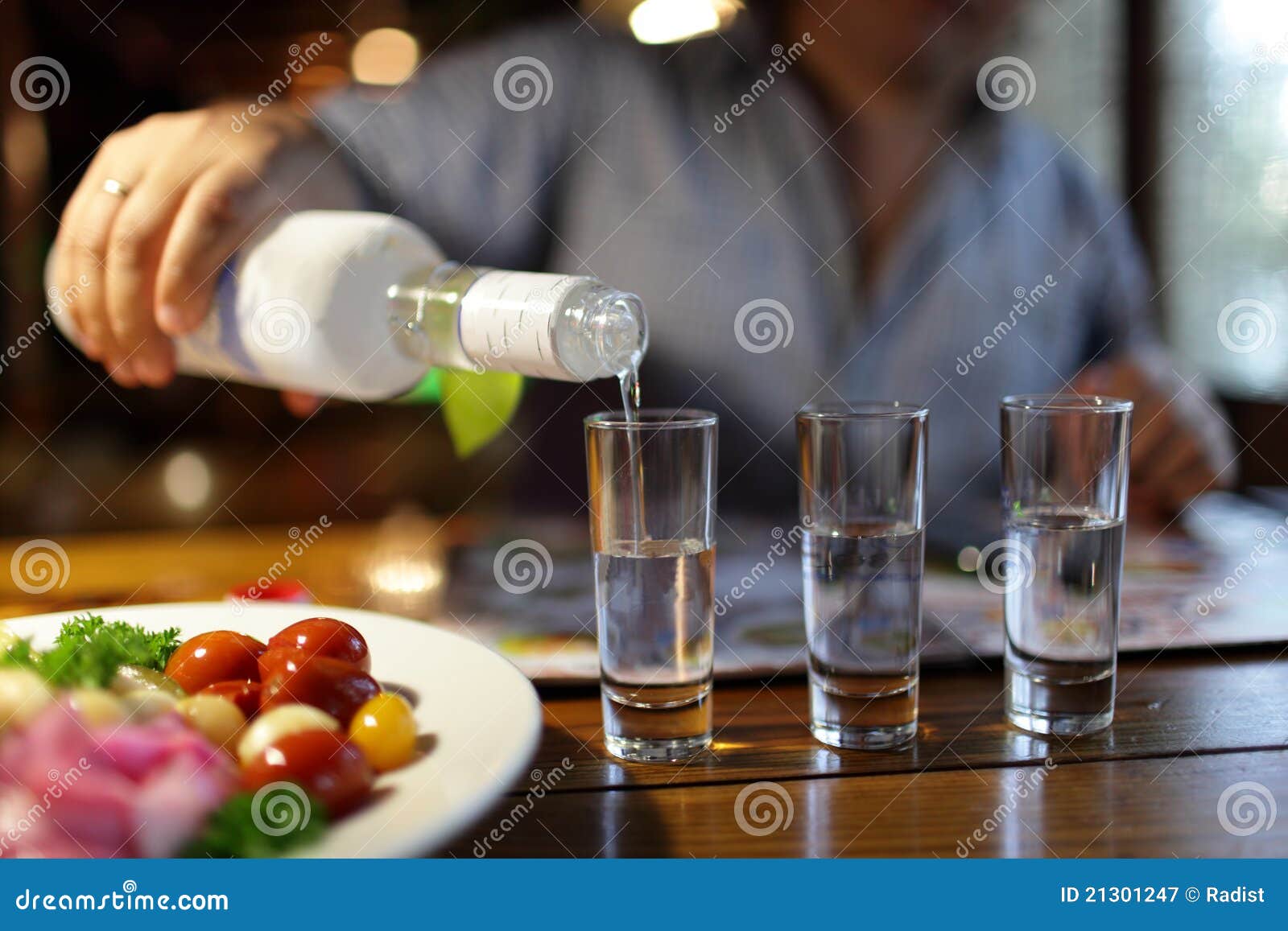 Man pouring vodka in pub stock image. Image of barkeeper - 21301247