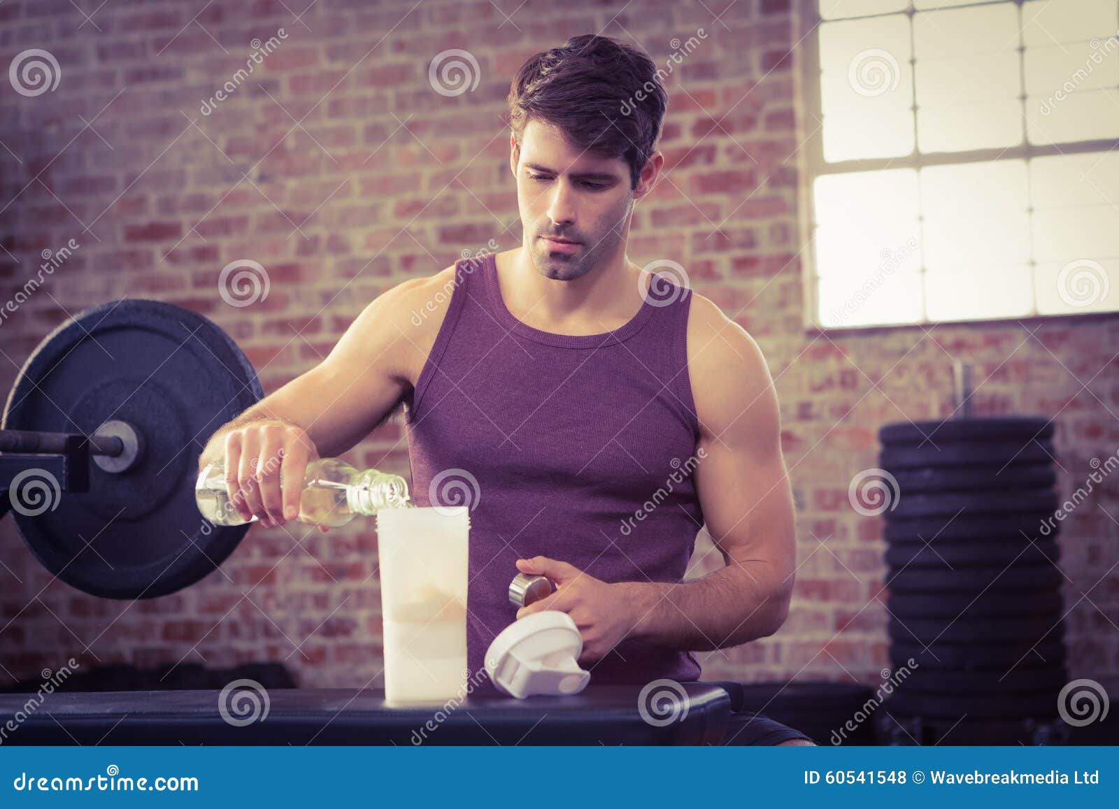 Man Pouring Water into Shaker Bottle Stock Photo - Image of studio ...