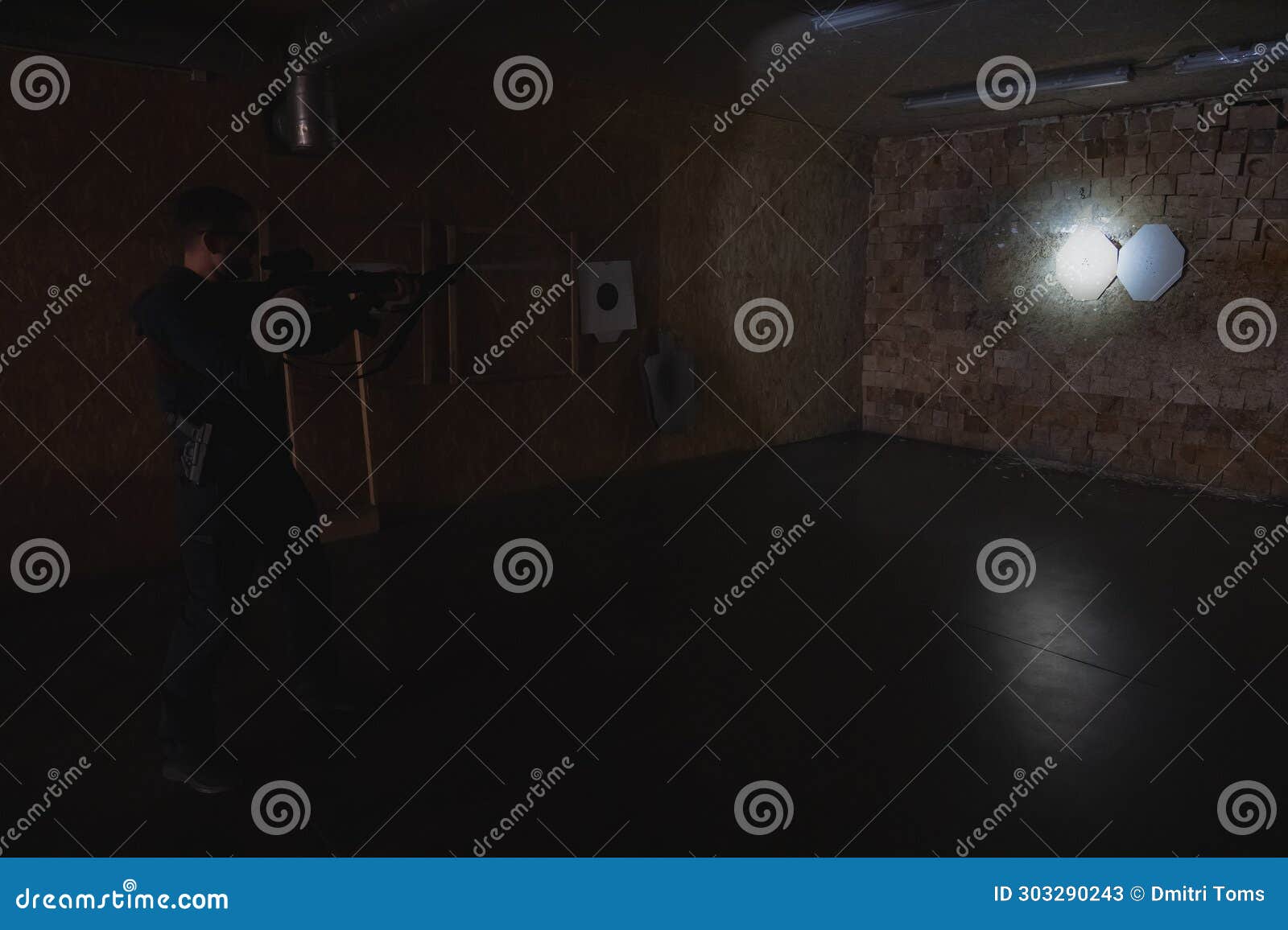 A Man Practices Tactical Shooting with a Rifle with a Weapon Flashlight ...