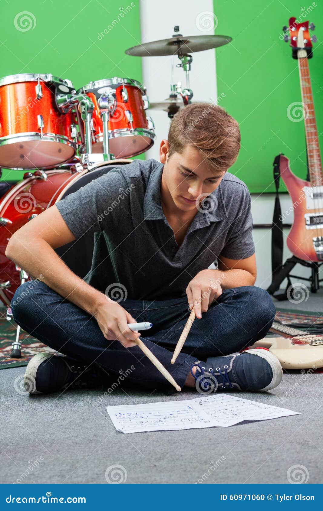 Man Practicing with Drumsticks while Looking at Stock Photo - Image of ...