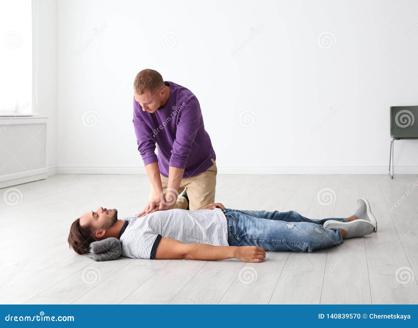 Man Practicing First Aid on Unconscious Man Stock Photo - Image of ...