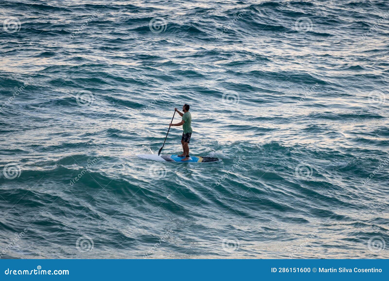 Man Practicing Paddle Surfing at Sunset on Altafulla Beach in Tarragona ...
