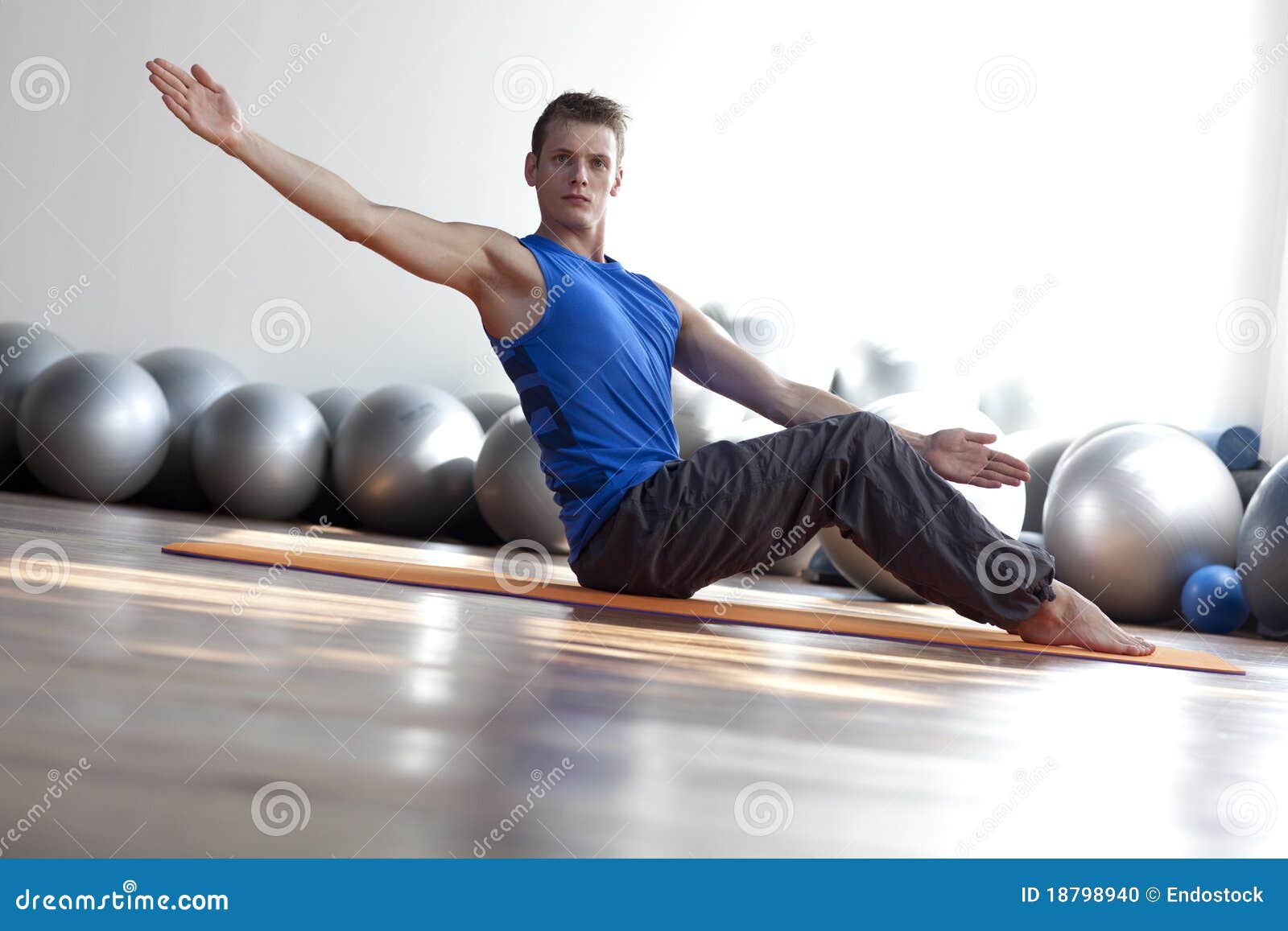 Man practicing pilates stock photo. Image of culture - 18798940