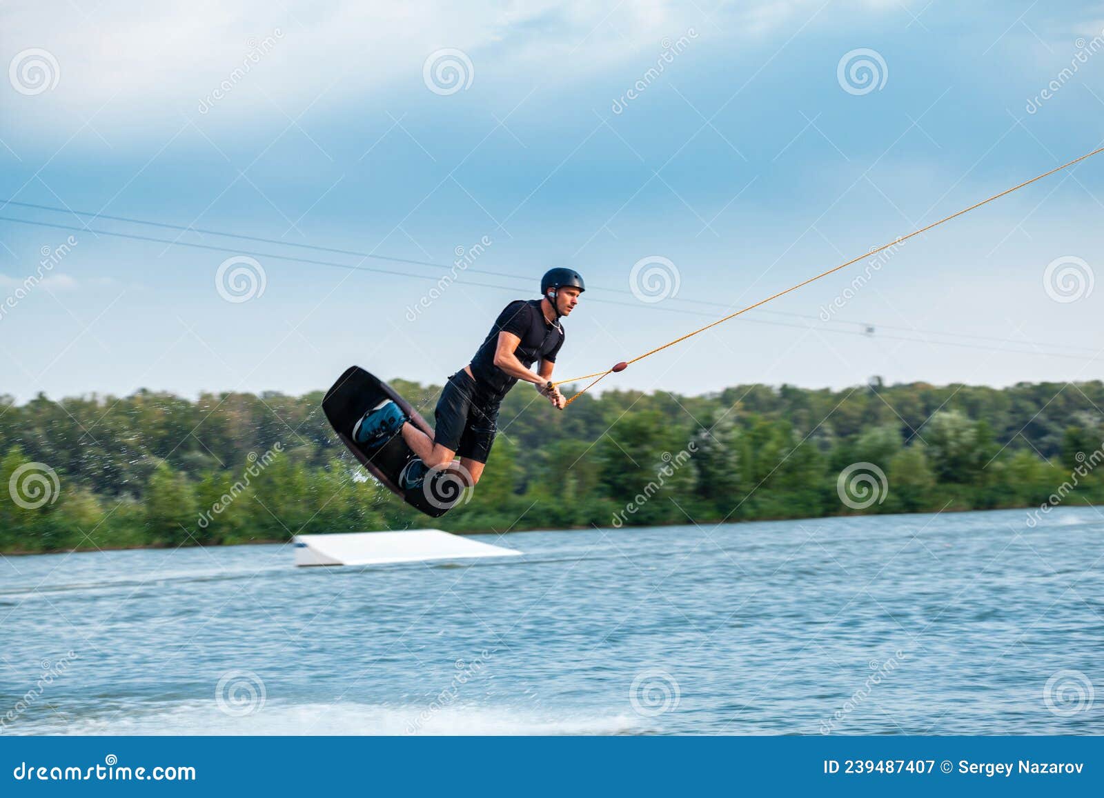 Man Practicing Technique of Jumping Over Water during Wakeboarding ...