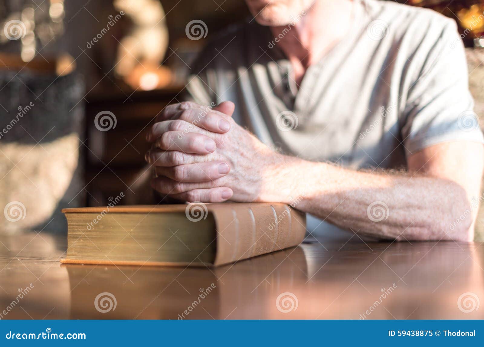 Man Praying Hands on a Bible Stock Image - Image of prayer, sitting ...