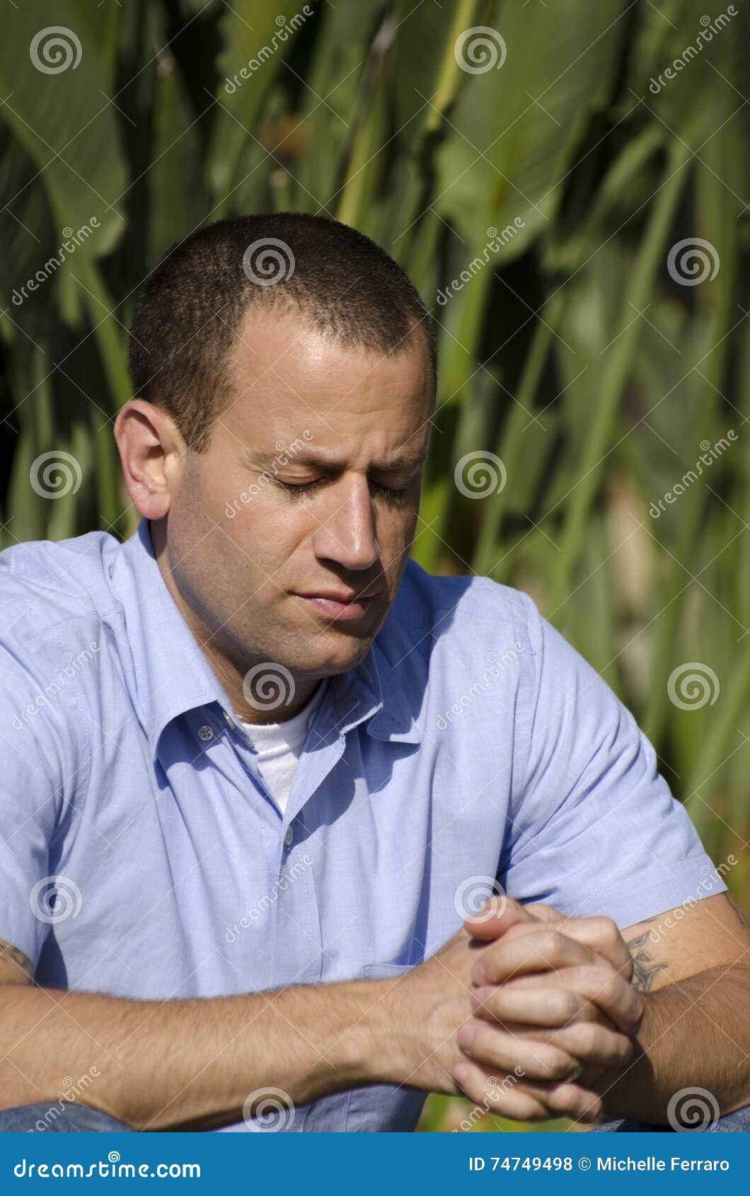 Man praying outside. stock photo. Image of pondering - 74749498