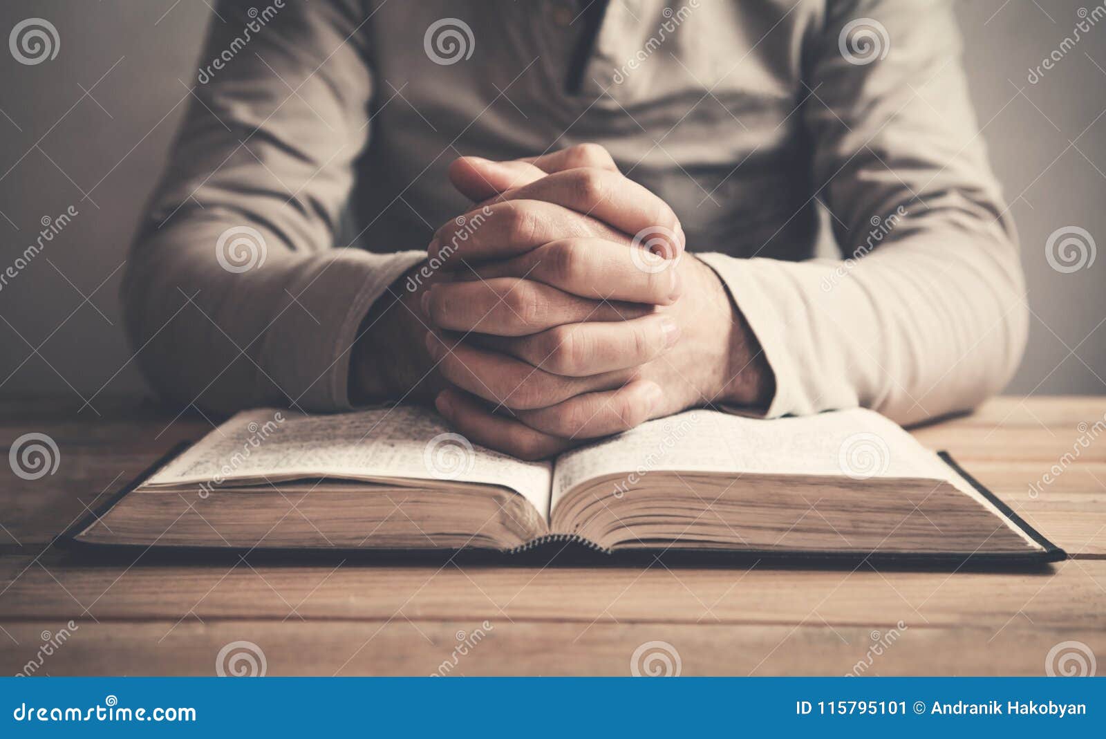 Man praying over a bible. stock image. Image of worship - 115795101