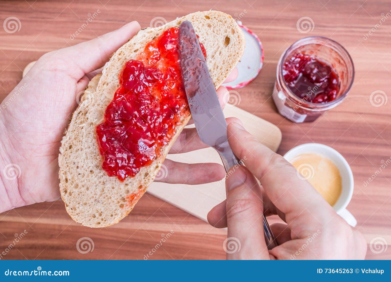 Man is Prepairing Breakfast and Spreading Jam on Slice of Bread Stock ...