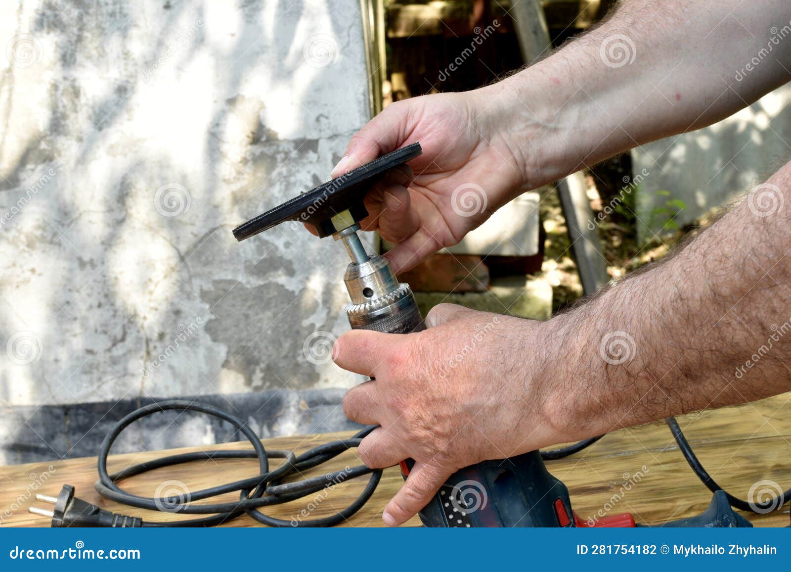 A Man Prepares a Drill for Grinding Work. Stock Photo - Image of ...