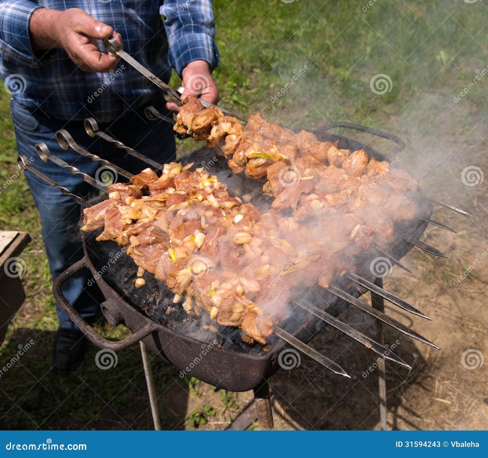 Man preparing barbecue stock image. Image of grill, grilling - 31594243