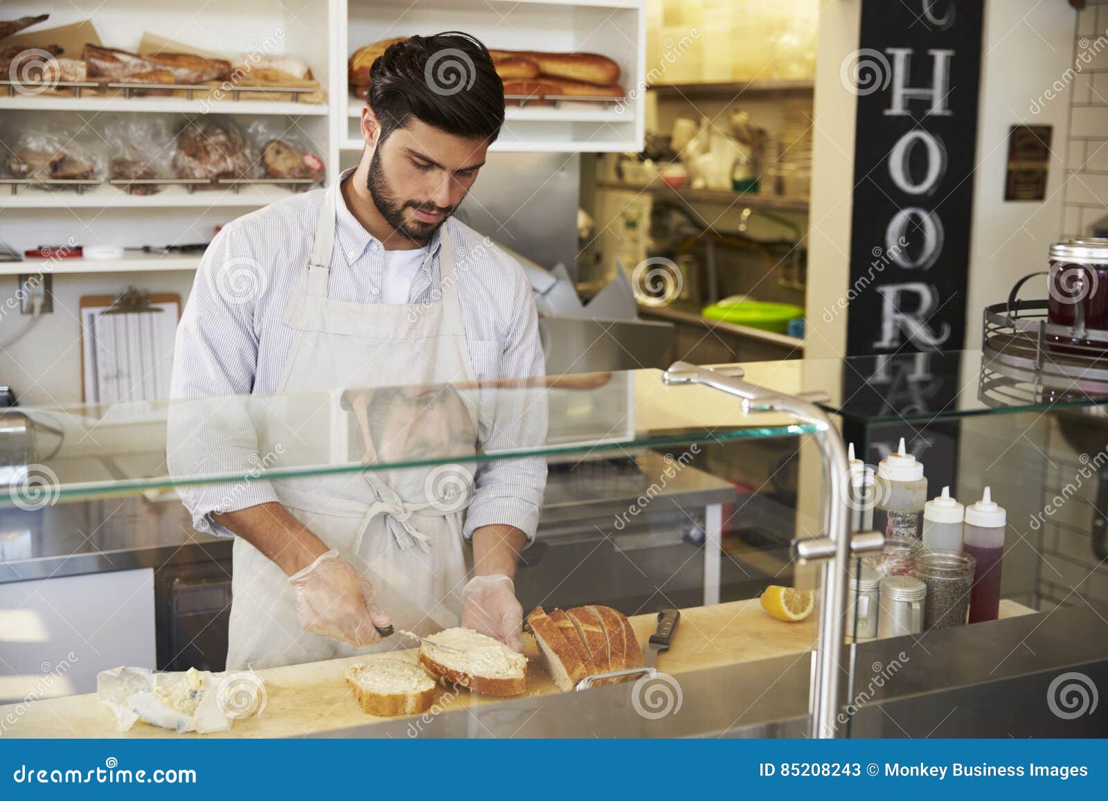 Man Preparing Food Behind the Counter at a Sandwich Bar Stock Image ...