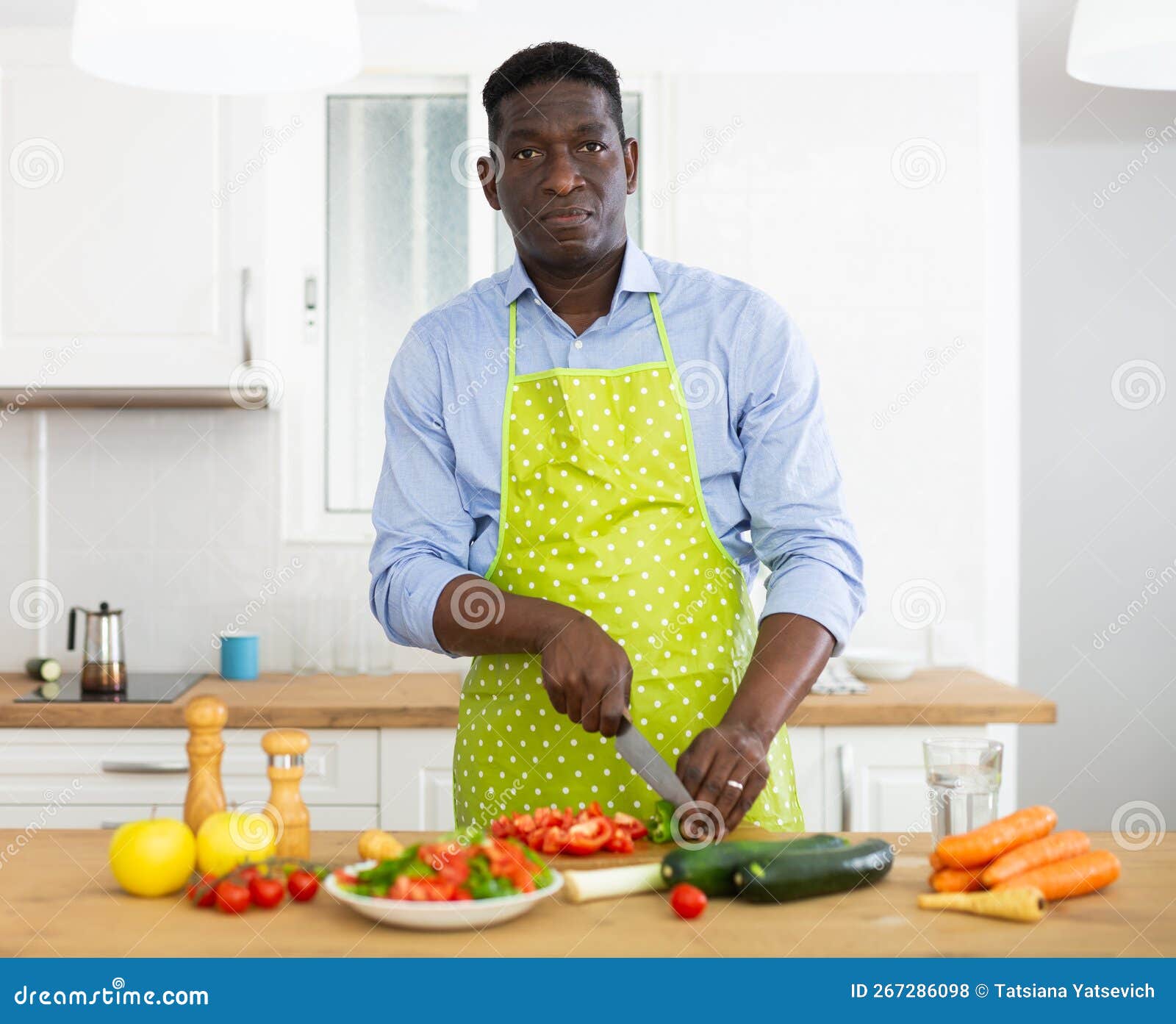 Man preparing food at home stock photo. Image of cooking - 267286098
