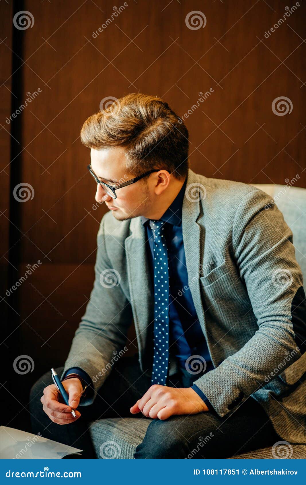 Man is Preparing for Interview. he in Suit, Sitting in Hall on Chair ... Man is Preparing for Interview. he in Suit, Sitting in Hall on Chair ...