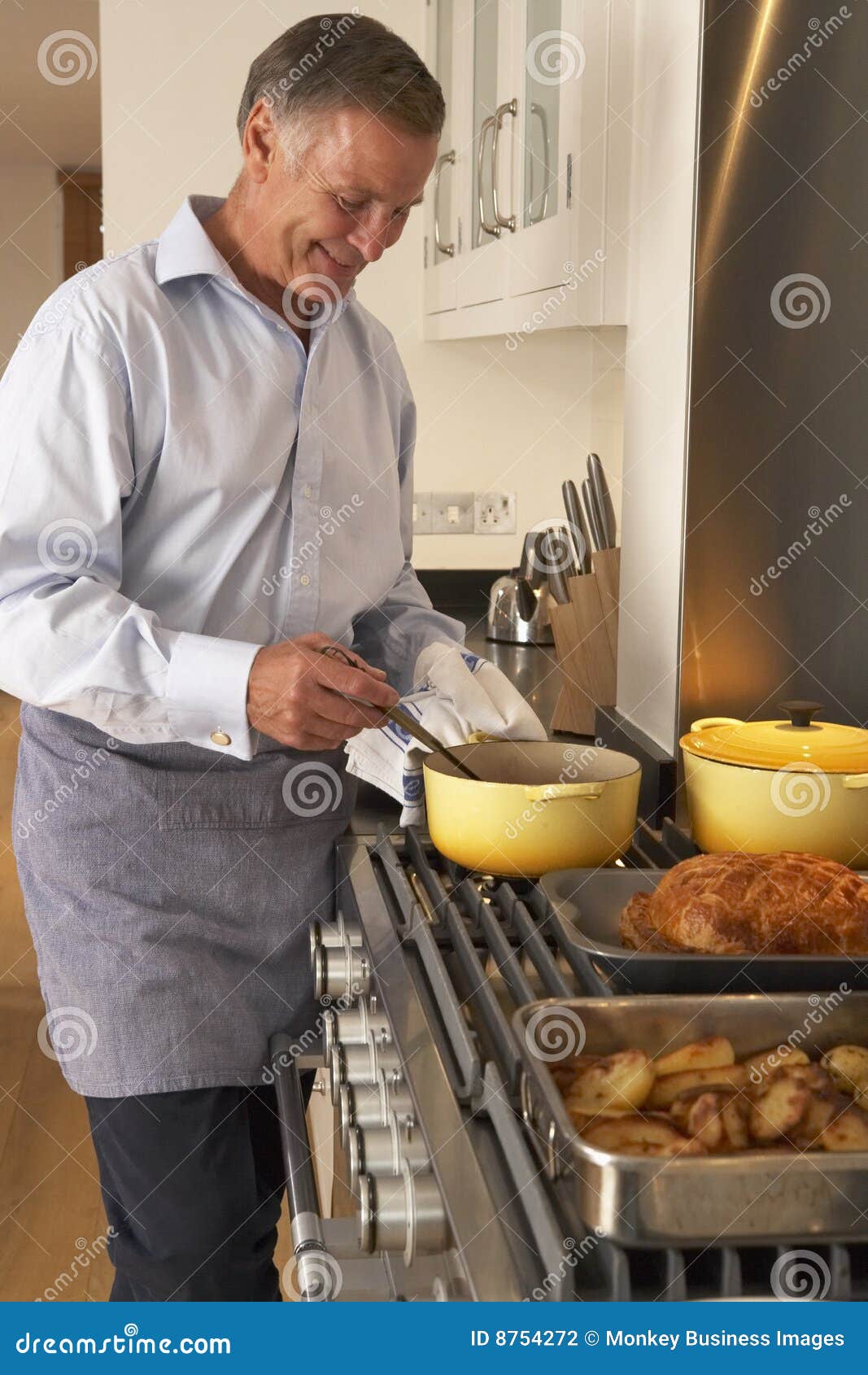 Man Preparing Meal at Home stock photo. Image of home - 8754272
