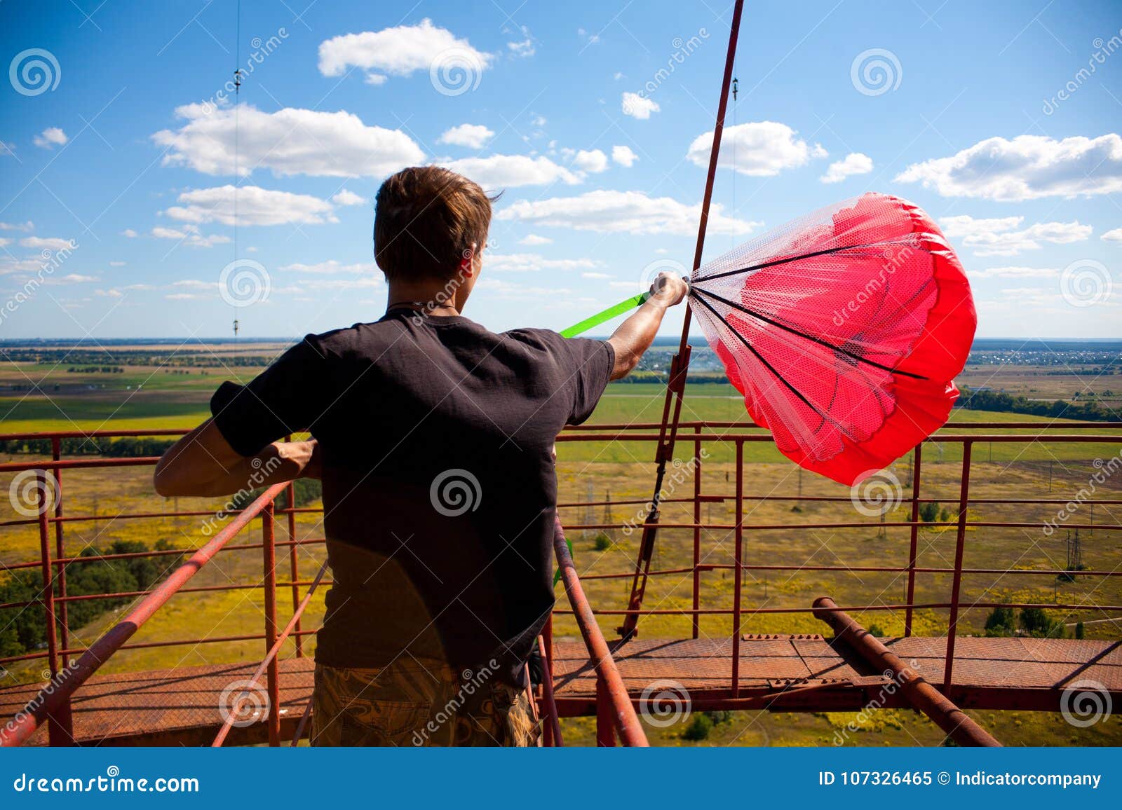 A Man is Preparing a Red Parachute for Base Jumping Editorial Image ...