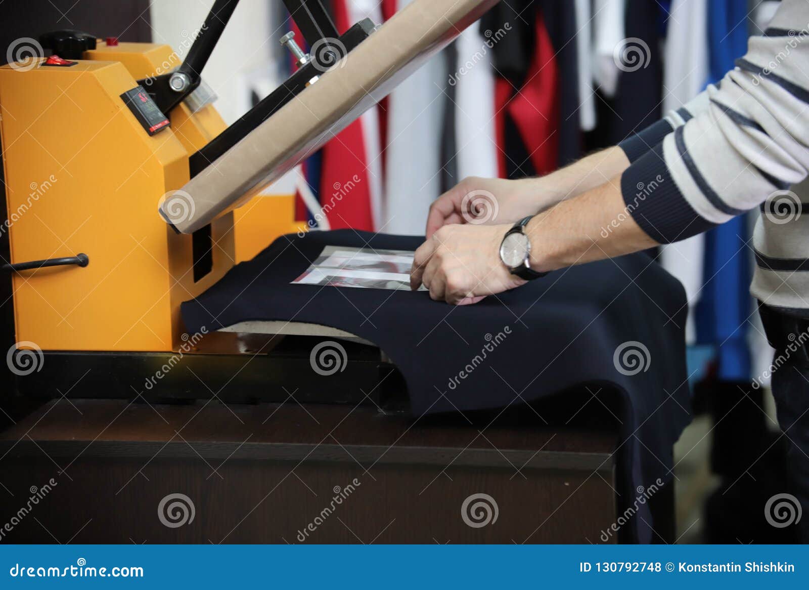 Man Preparing T-shirt for Printing in the Silk Screen Printing Machine ...