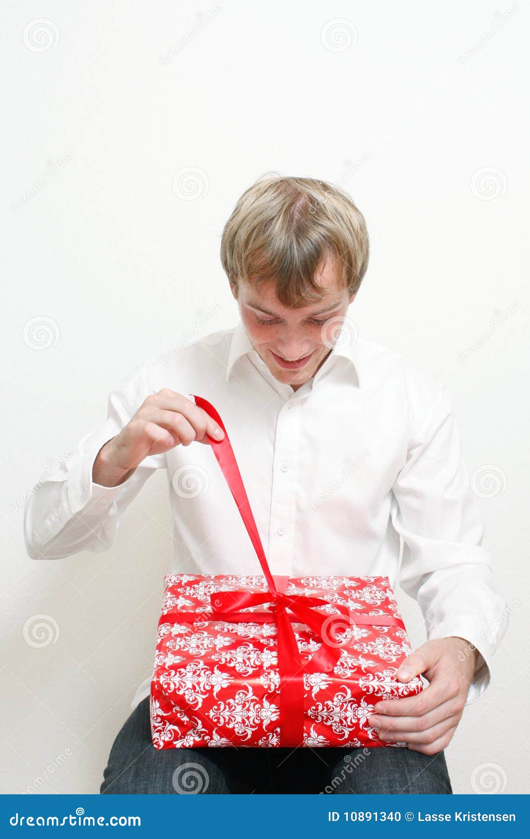Man with present stock photo. Image of smile, sitting - 10891340