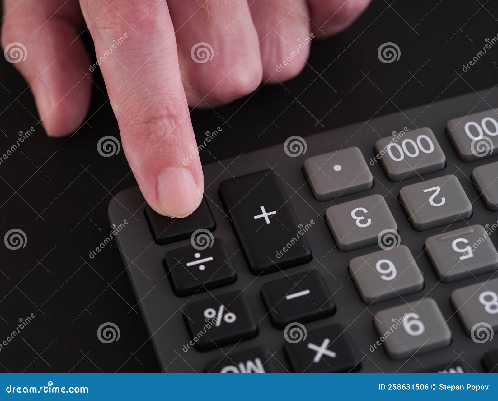 A Man Pressing the Equals Button on a Calculator Stock Photo - Image of ...