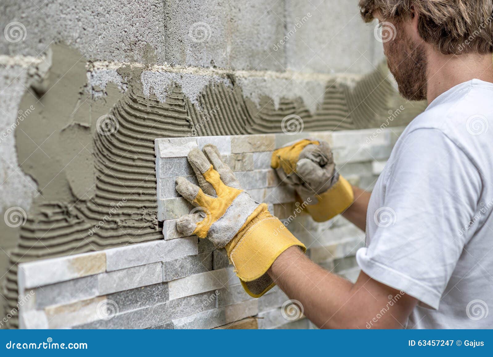 Man Pressing an Ornamental Tile into a Glue on a Wall Stock Image ...