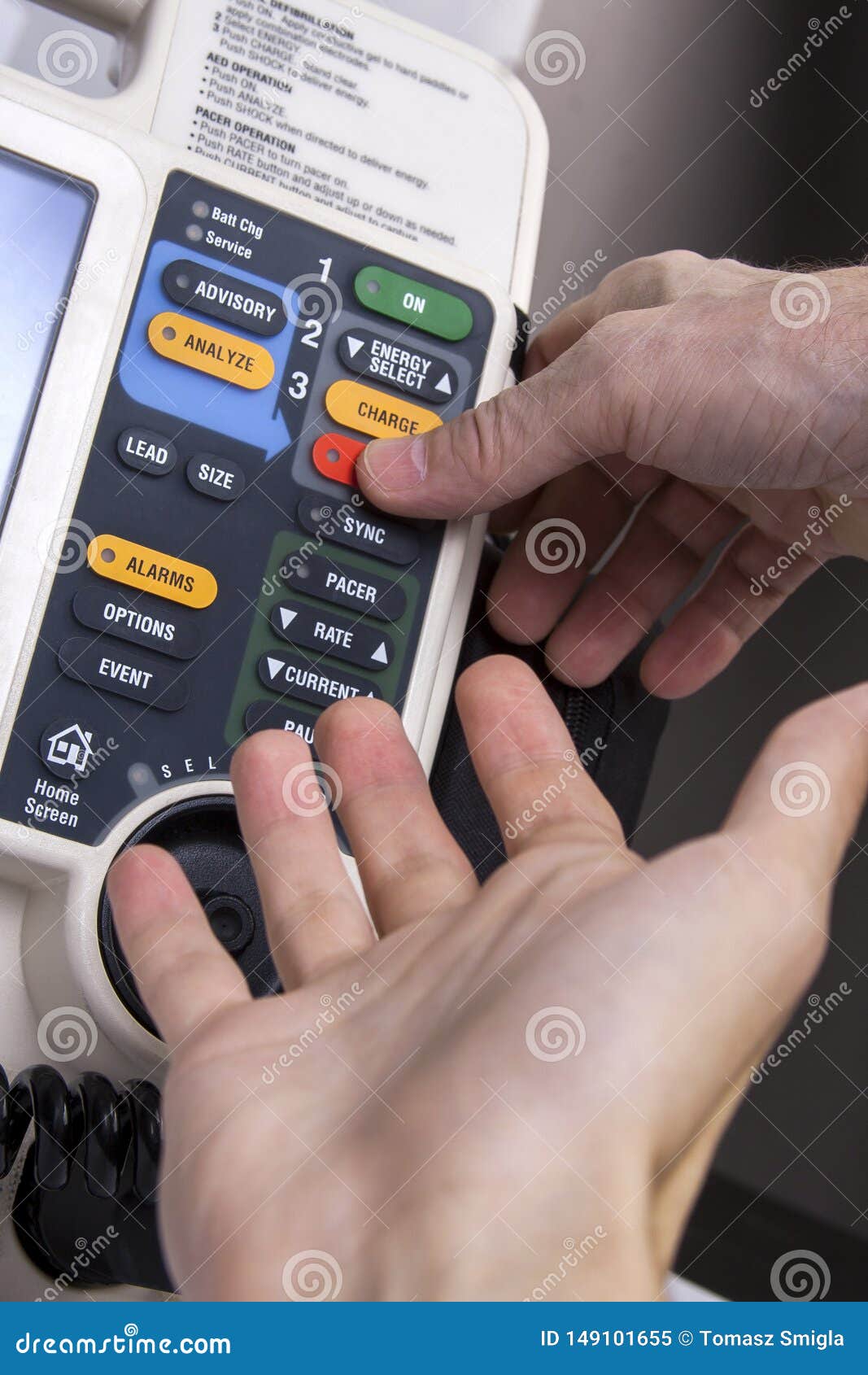 Man Pressing Red Button on a Modern Defibrillator Stock Image - Image ...
