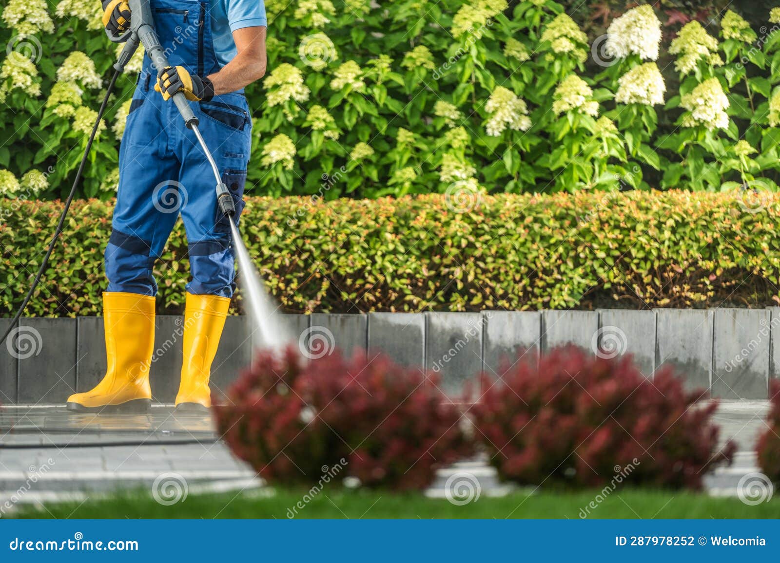 Man Pressure Washing Driveway Using Modern Pressure Washer Stock Photo ...