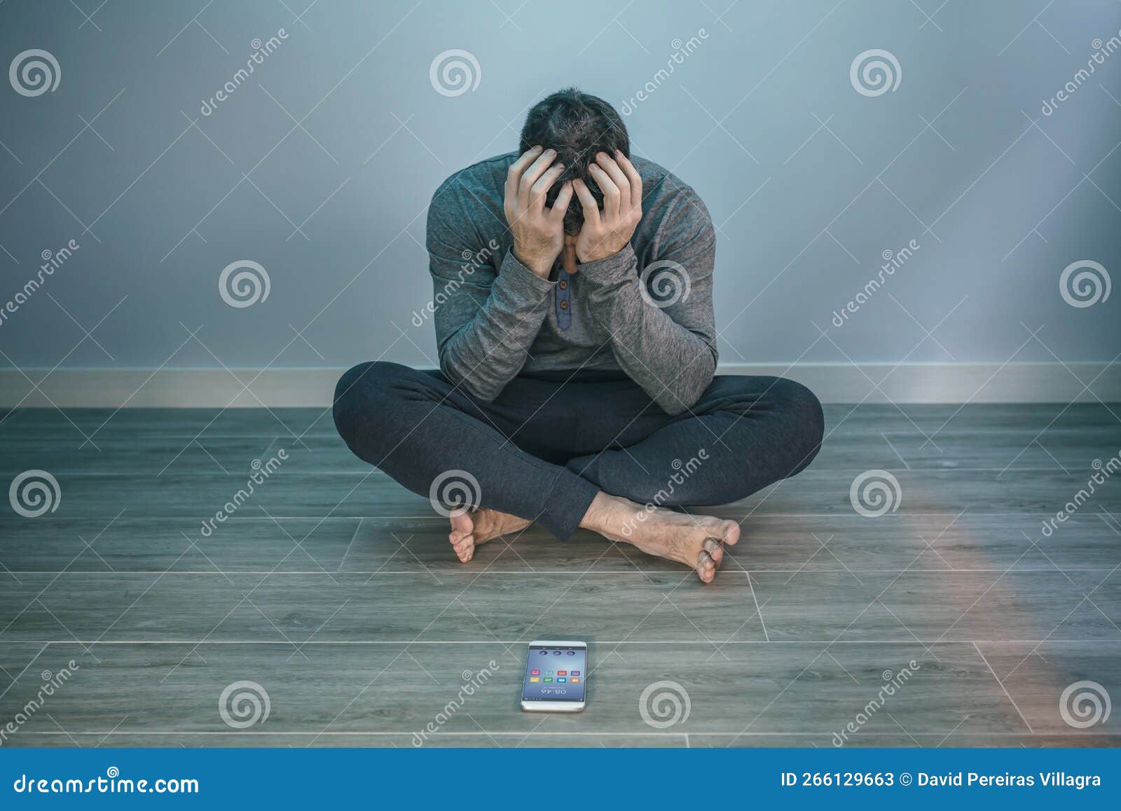 Man with Problems Sitting on the Floor Behind of His Mobile Stock Image ...