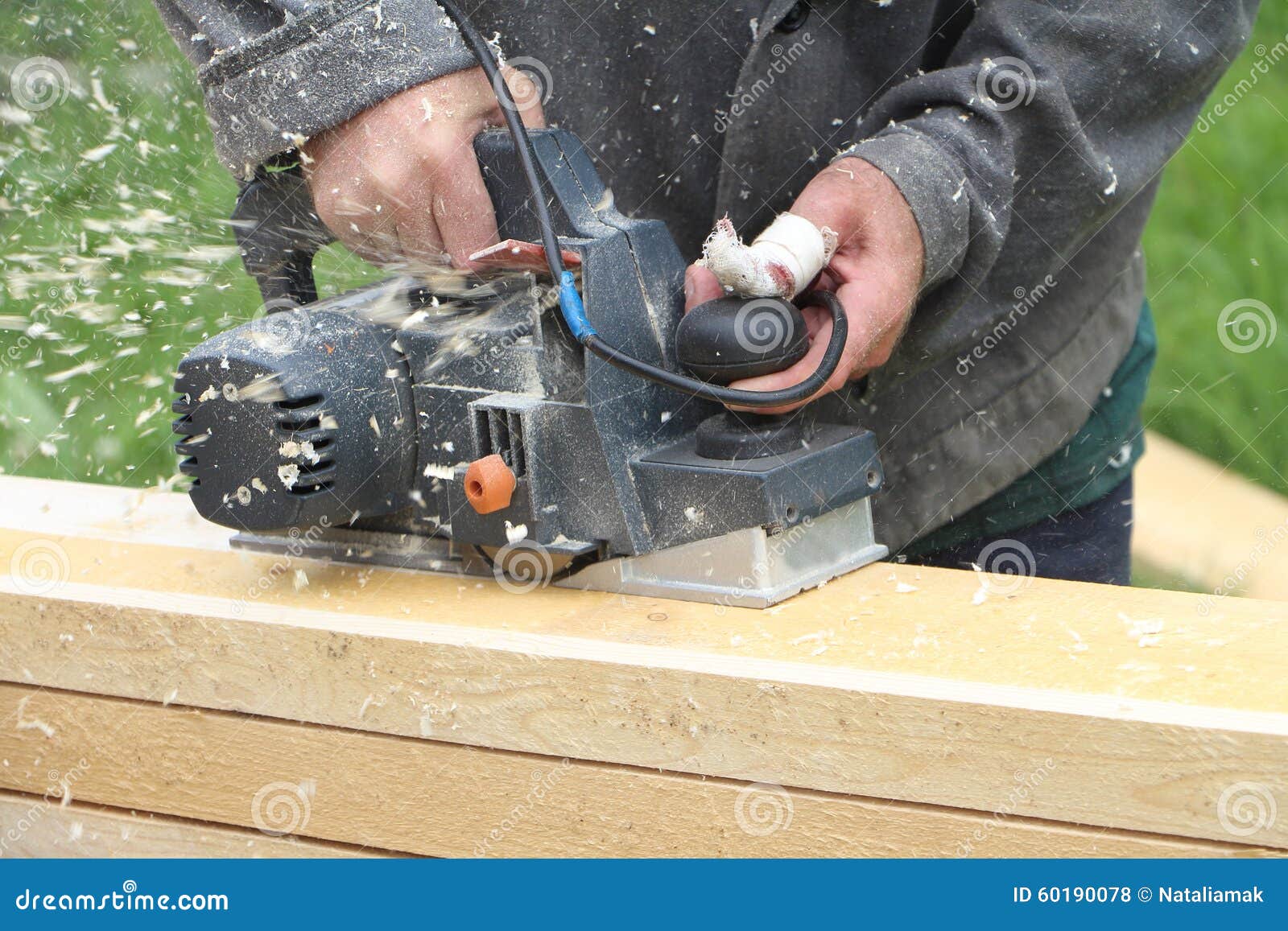 The Man Processes a Board a Electric Planer Outdoors Stock Photo ...