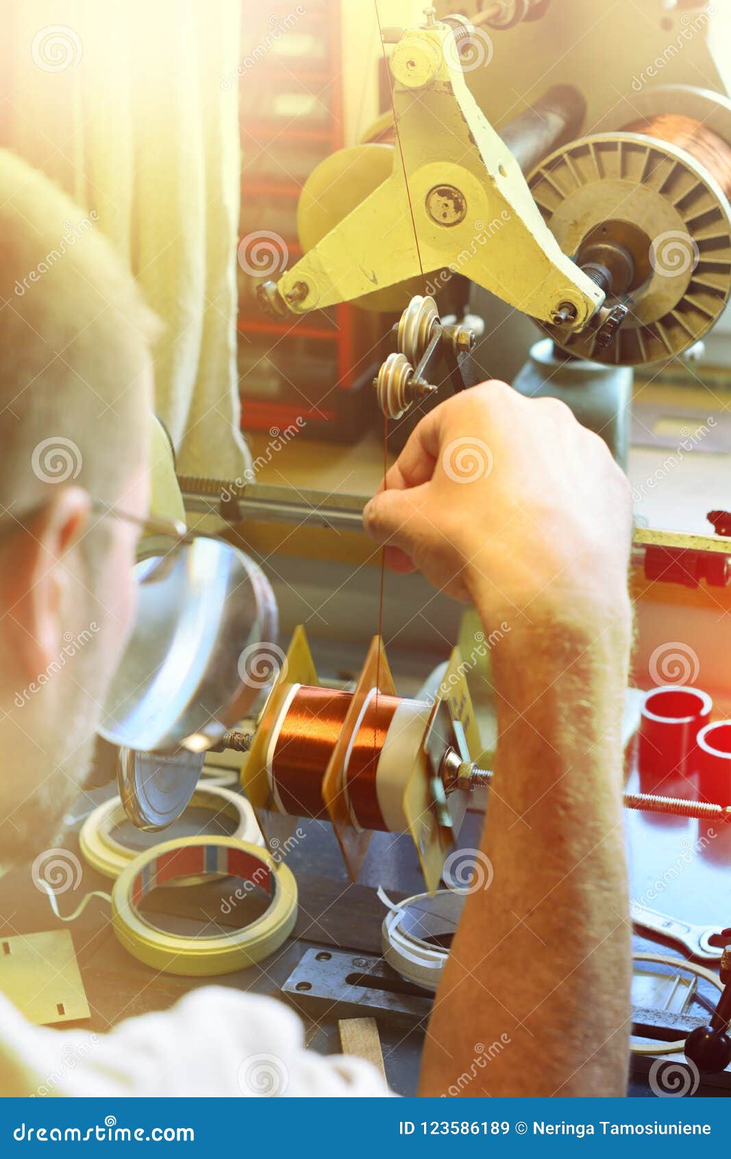 A Man Producing an Electrical Copper Coil for High-voltage Trans ...