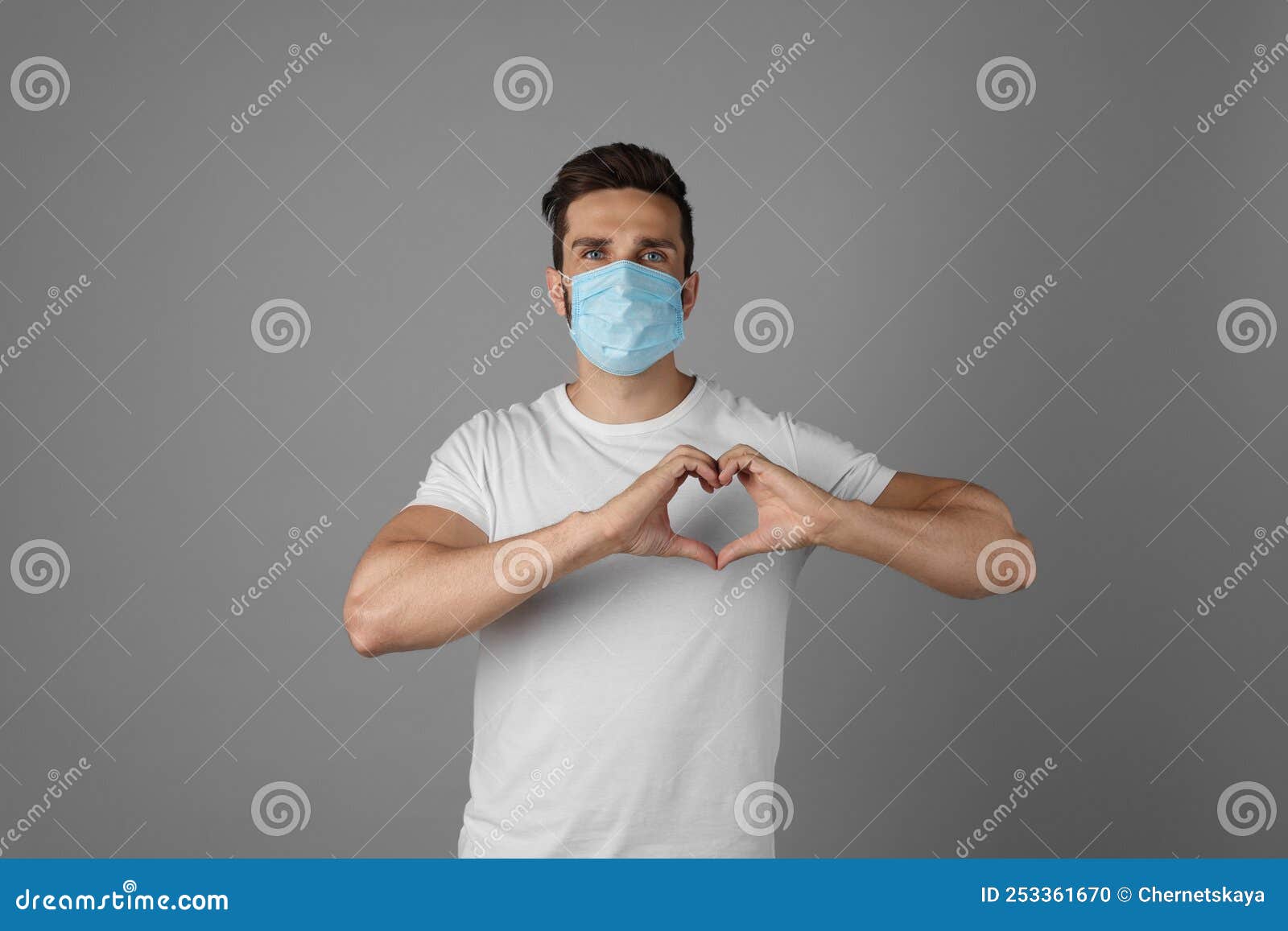 Man in Protective Mask Making Heart with Hands on Background Stock ...