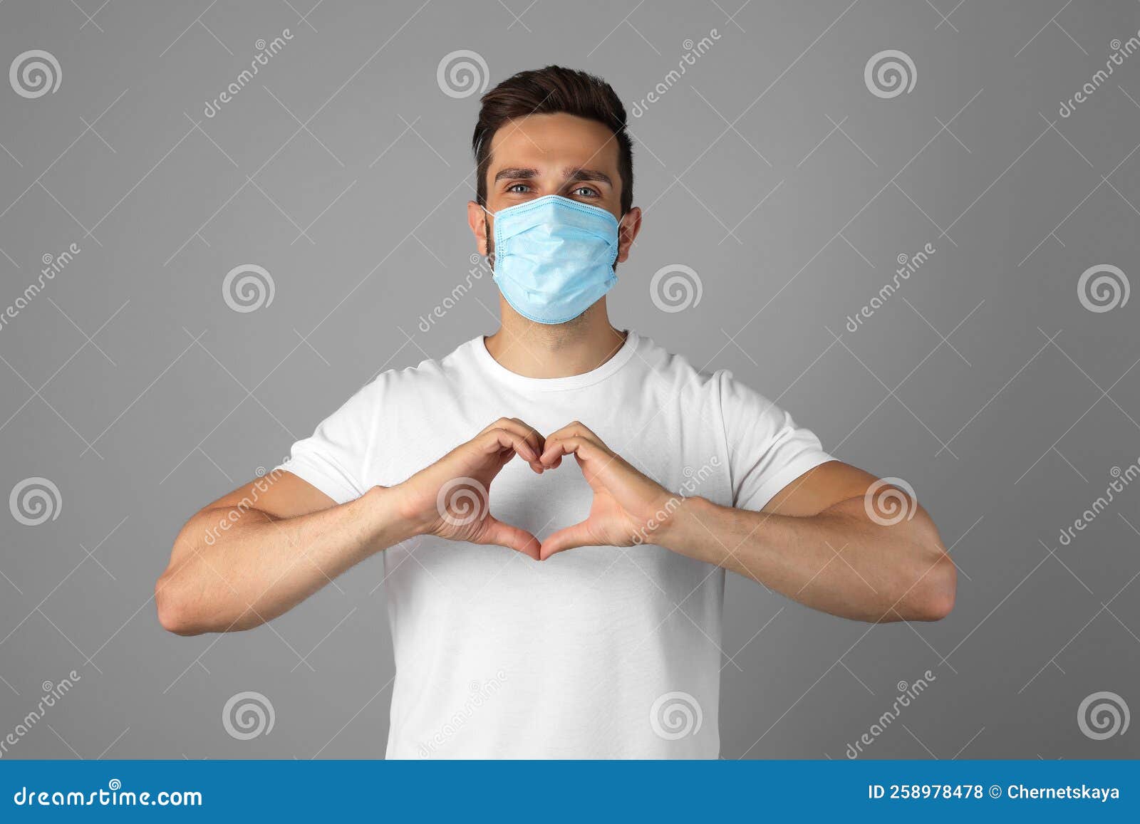 Man in Protective Mask Making Heart with Hands on Grey Background Stock ...