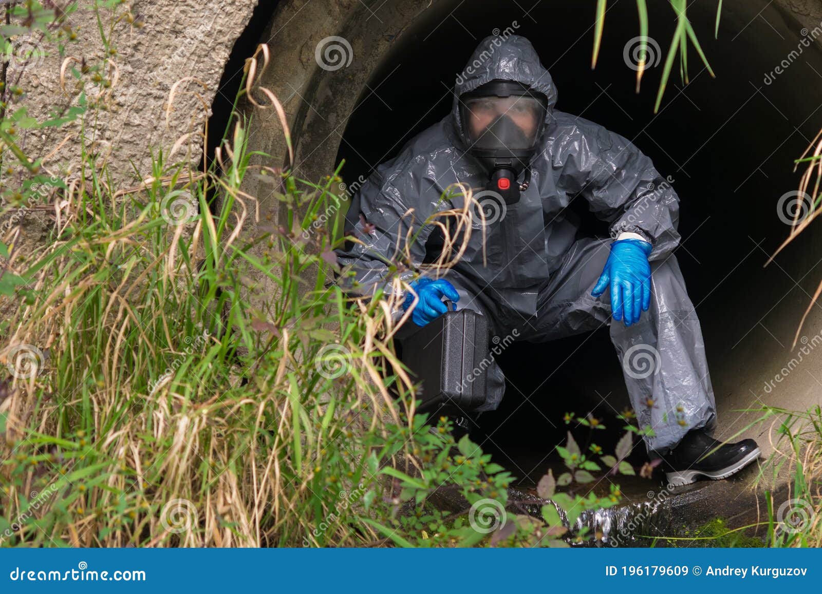 Man in Protective Suit and Mask Crawls Out of the Sewer after Research ...