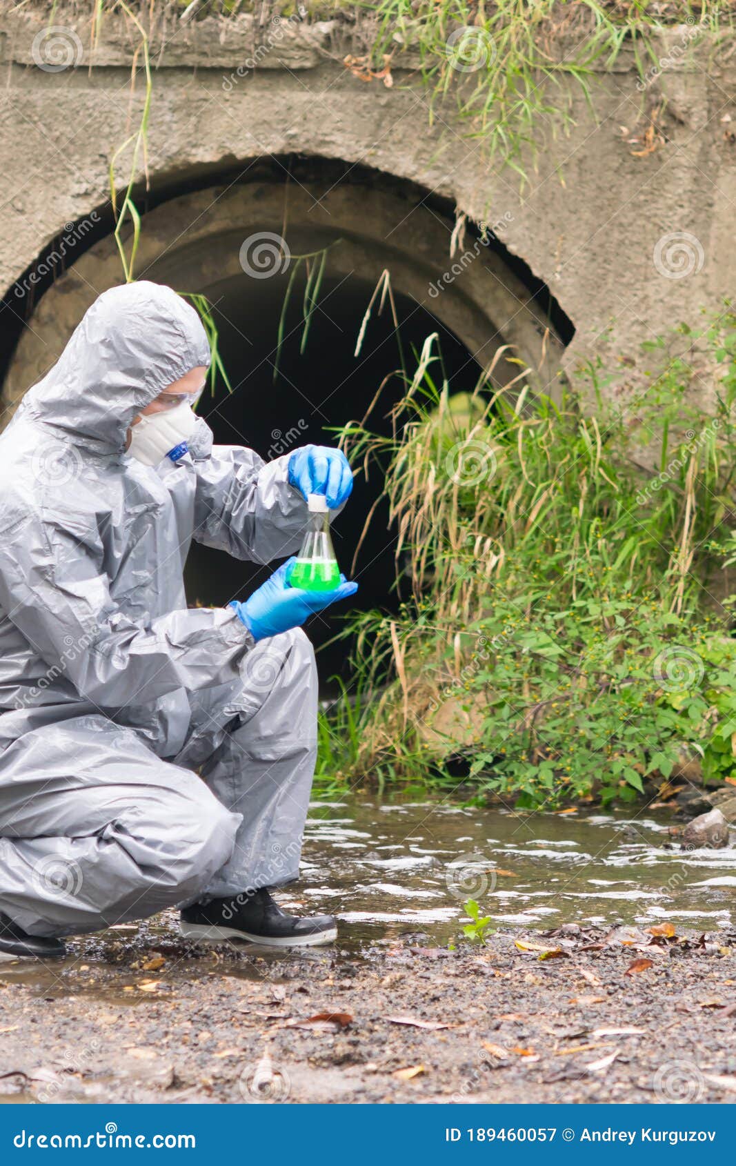 A Man in a Protective Suit and Mask Performs an Express Test for Water ...